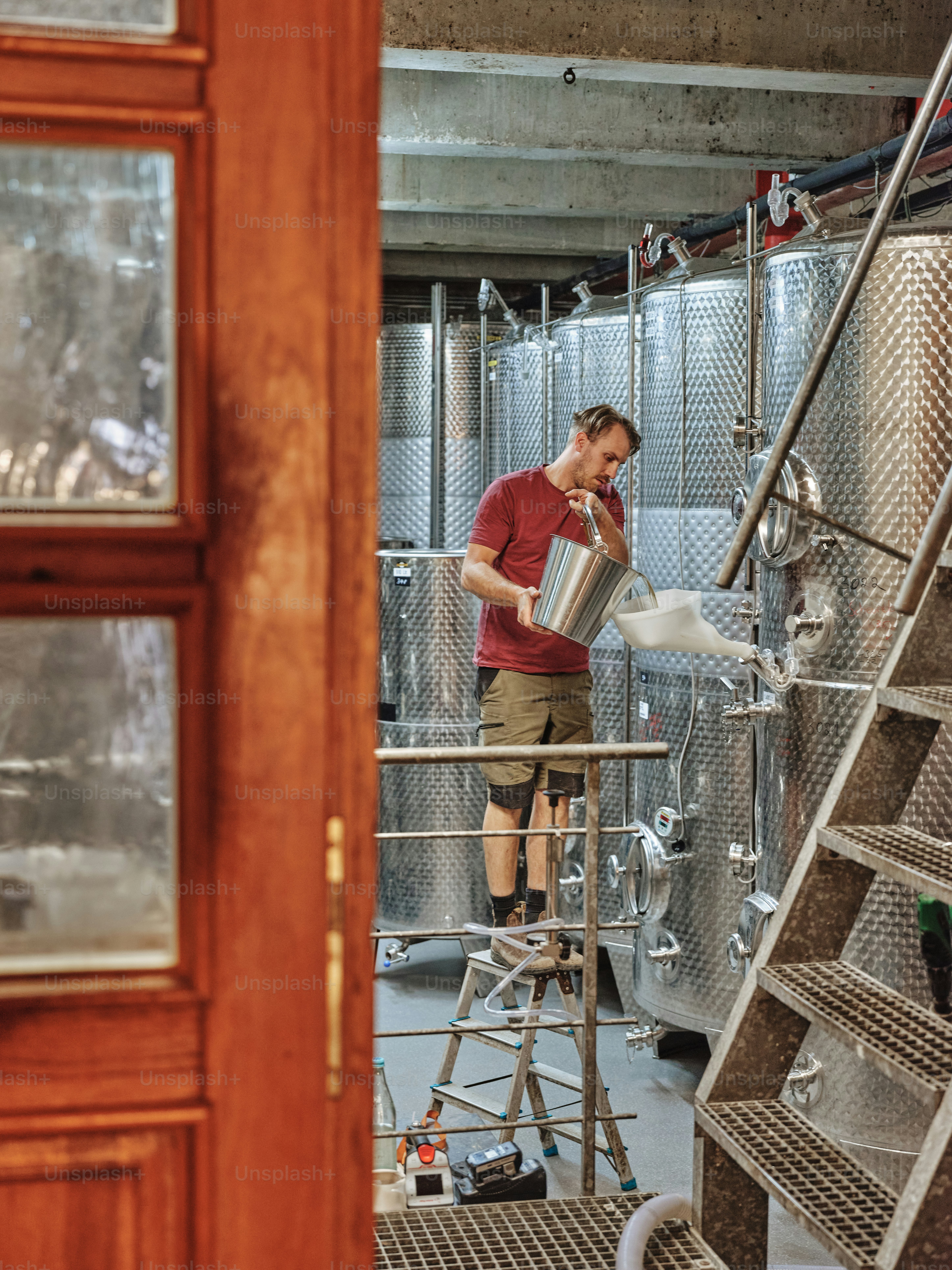 A man standing in front of a bunch of tanks photo – Agriculture Image ...