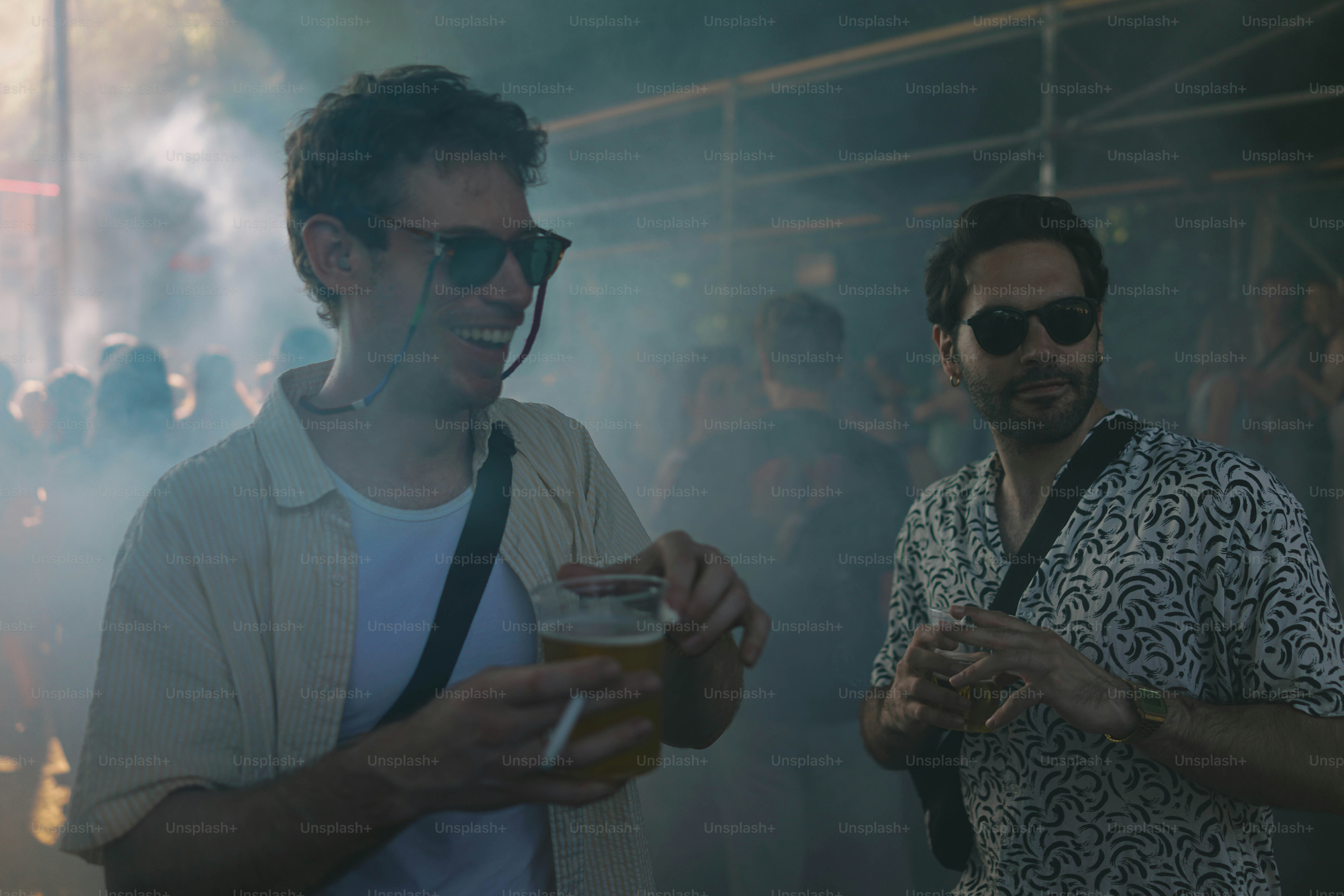 Two men standing next to each other in front of a crowd photo ...