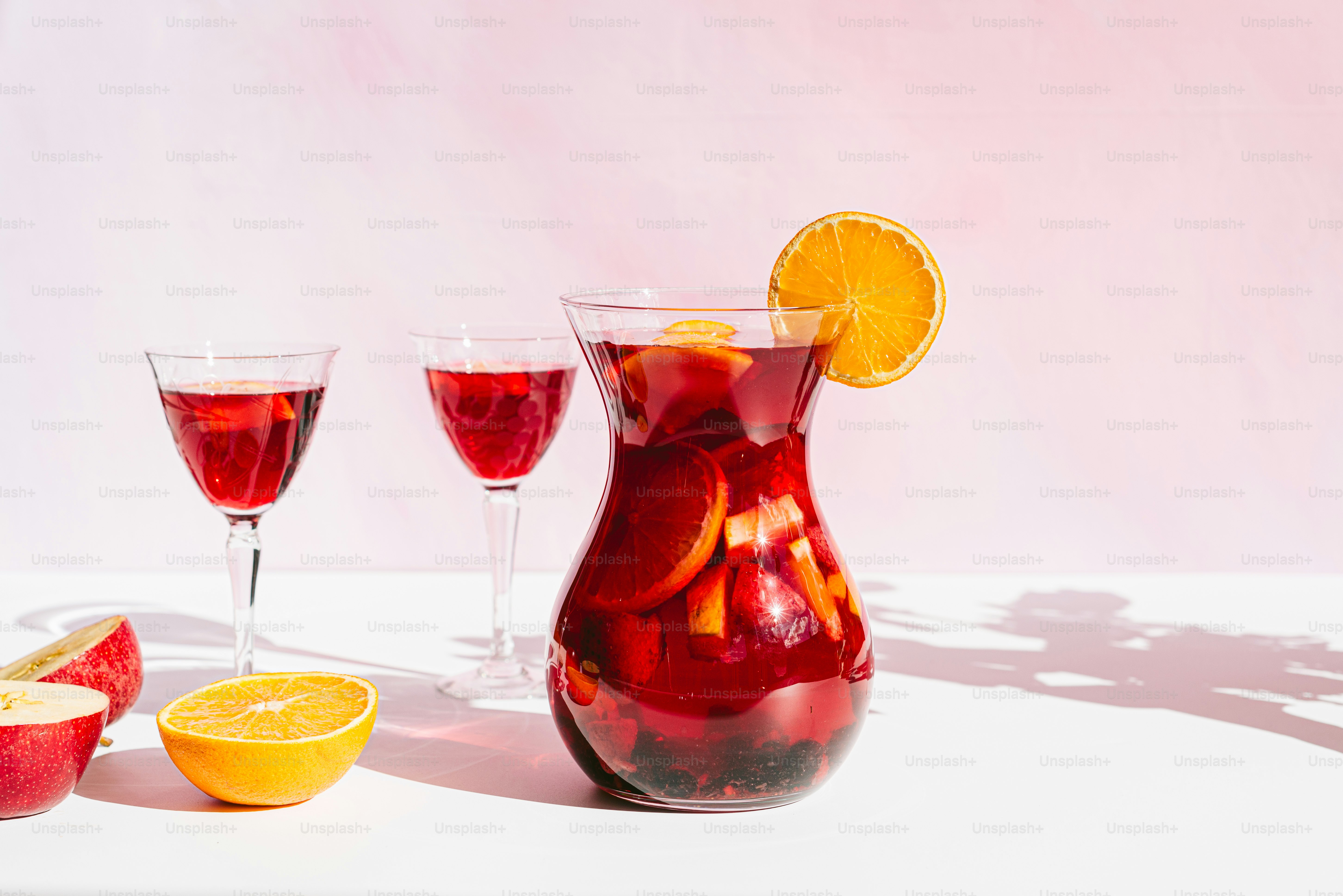 A pitcher of wine and three glasses of wine photo – Sangria Image on ...