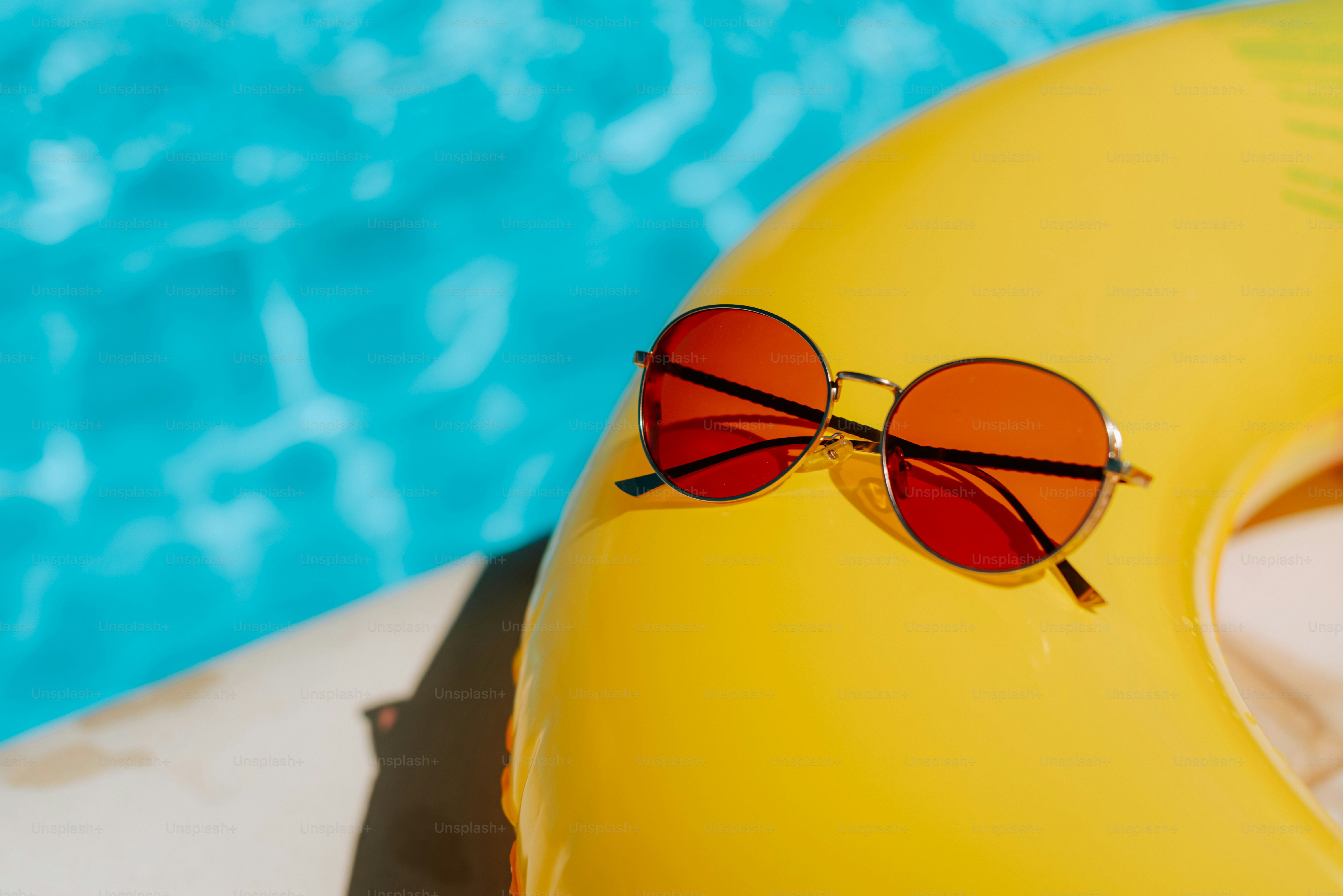 A yellow life preserver sitting next to a swimming pool photo – Summer ...