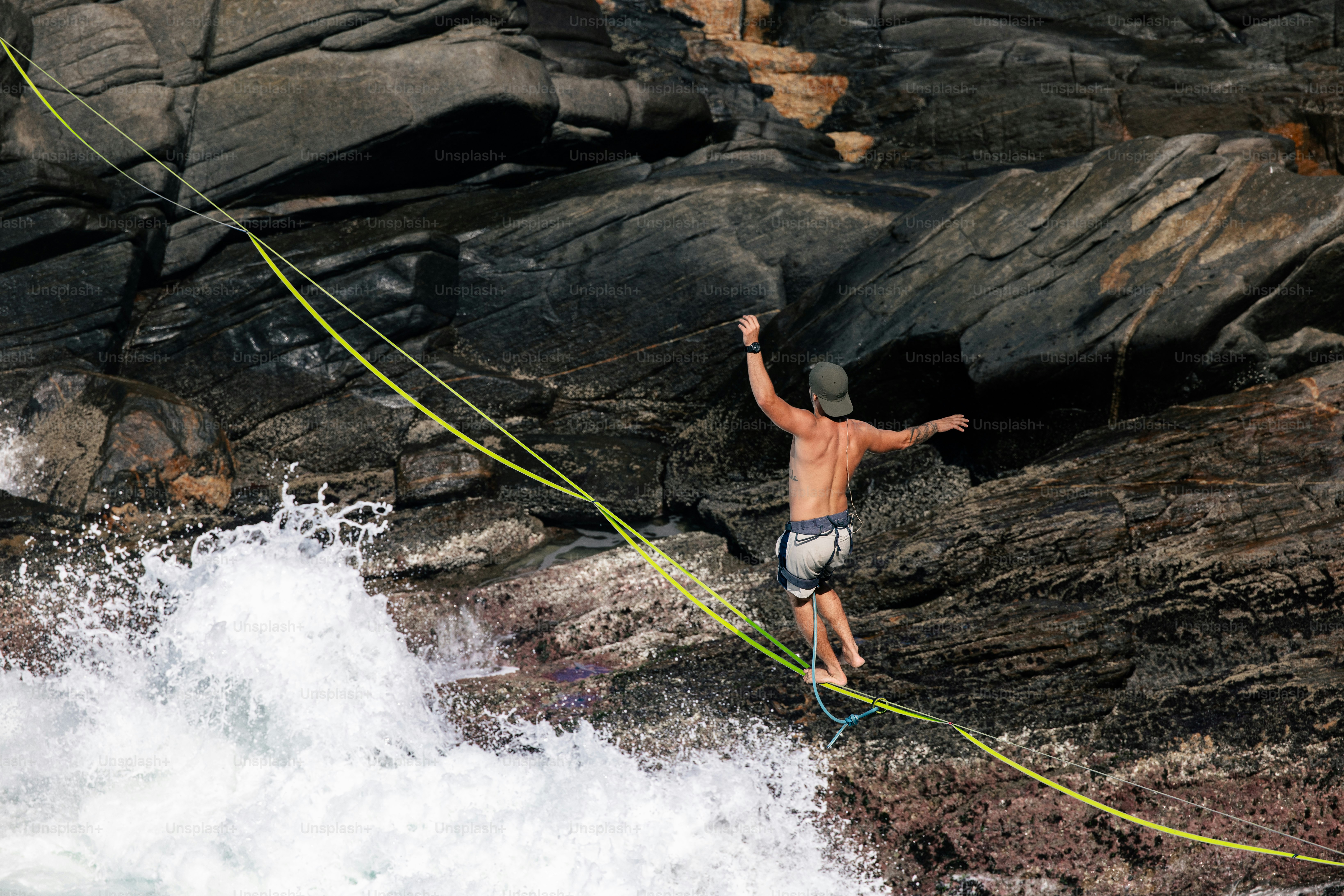 A man is on a rope above a body of water photo – Sport Image on Unsplash
