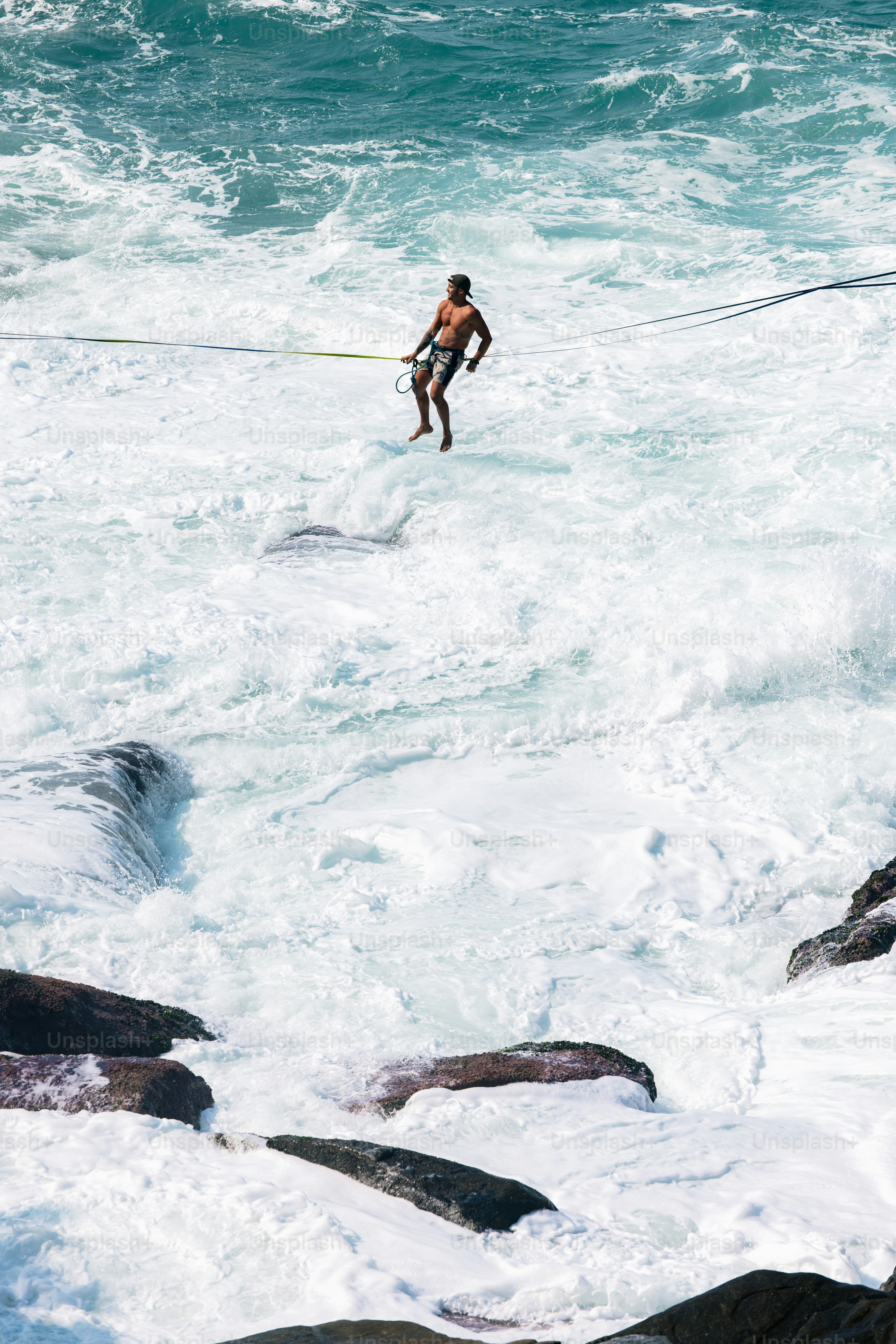 A man riding a wave on top of a surfboard photo – Agility Image on Unsplash