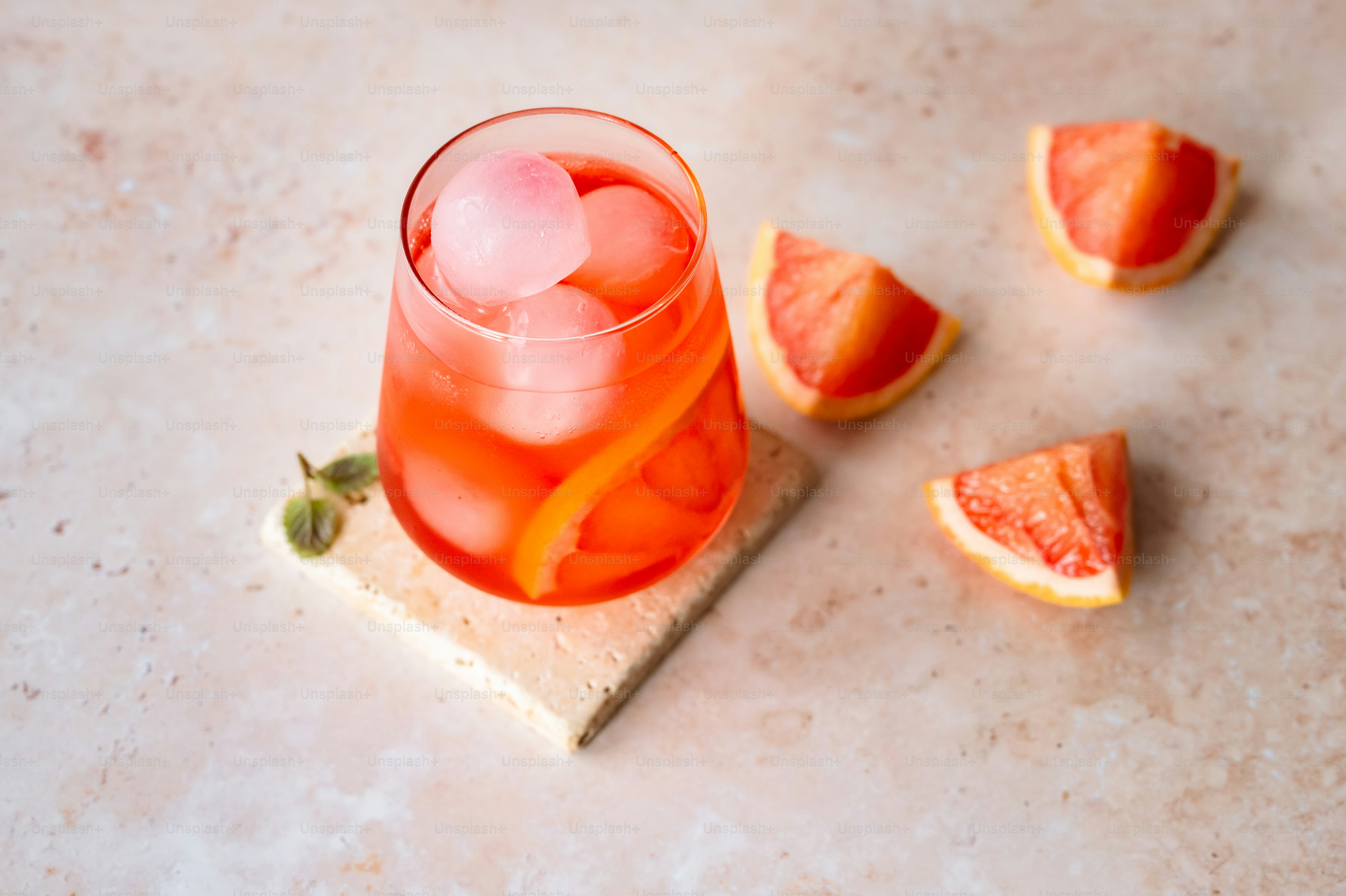 A glass of watermelon and a slice of grapefruit photo – Summer Image on ...