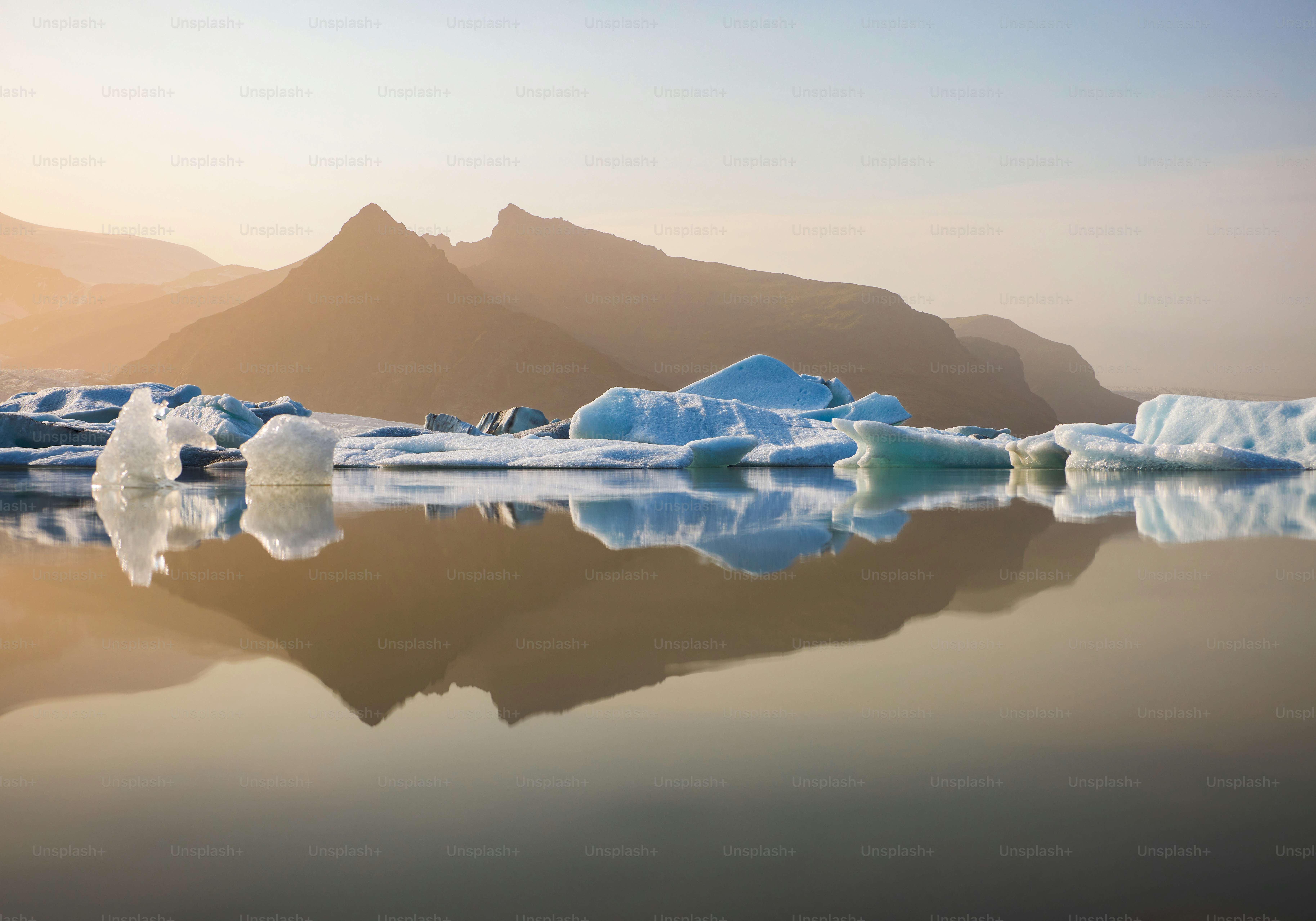 A group of icebergs floating on top of a lake photo – Iceland Image on ...