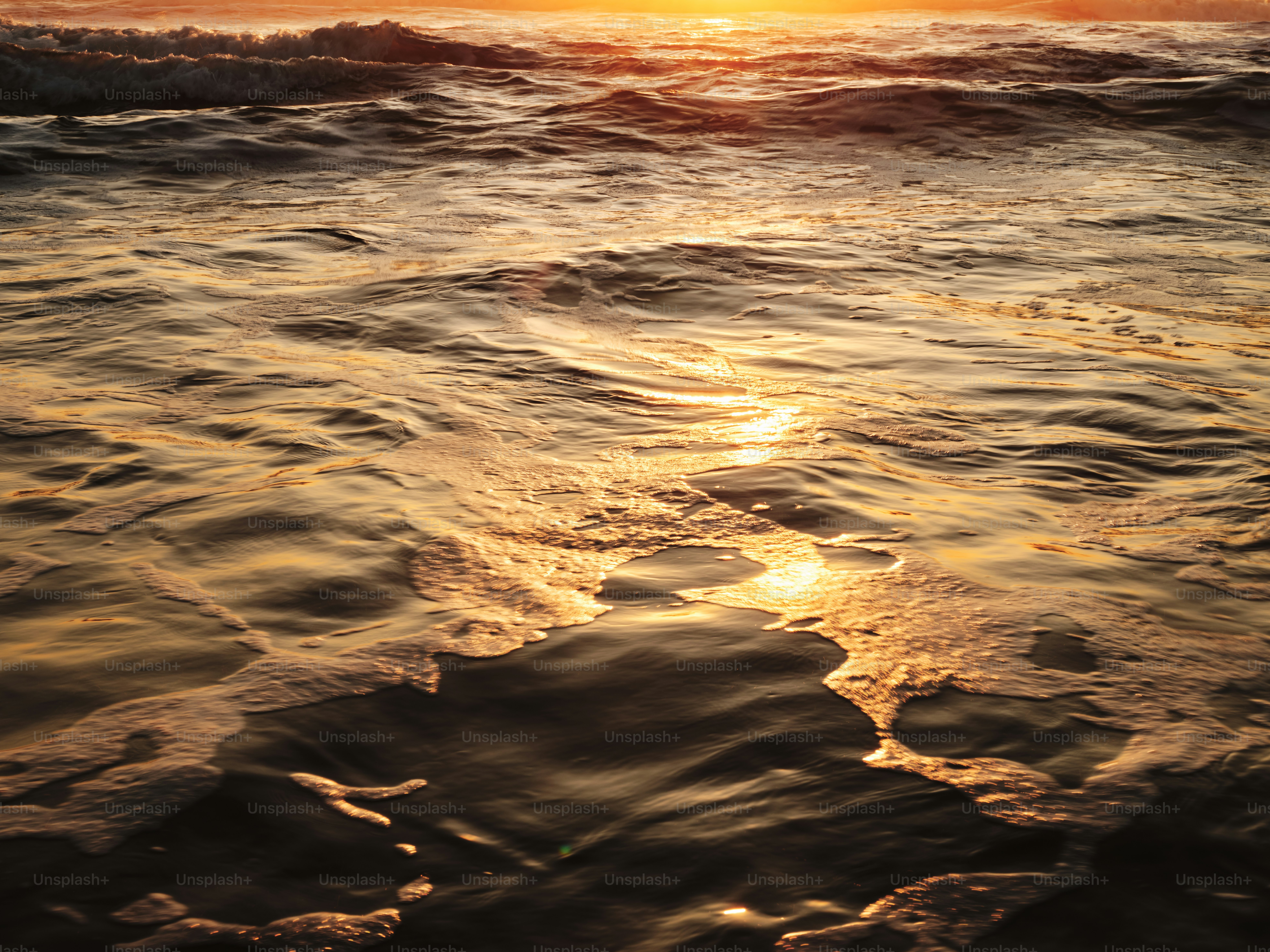 The sun is setting over a body of water photo – Ocean Image on Unsplash