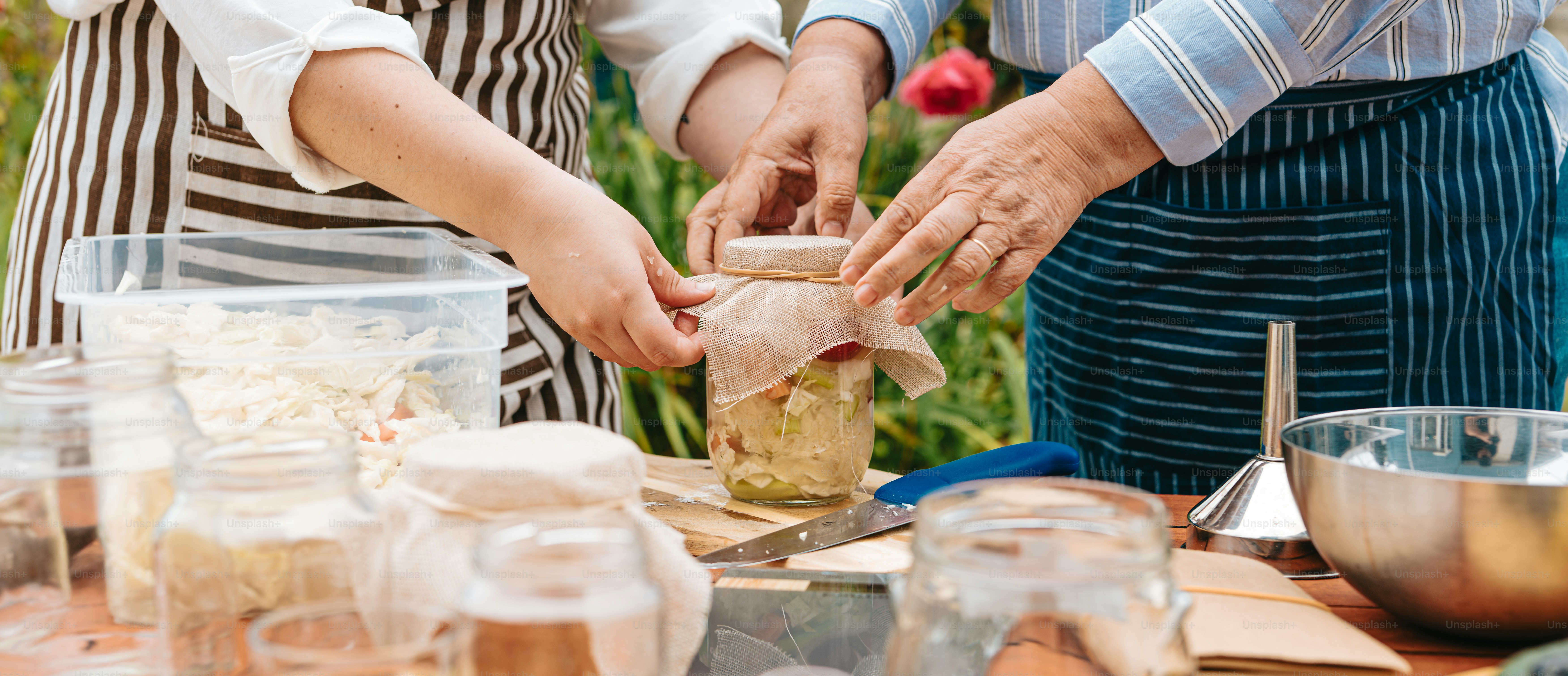 A group of people preparing food on a table photo – Food Image on Unsplash