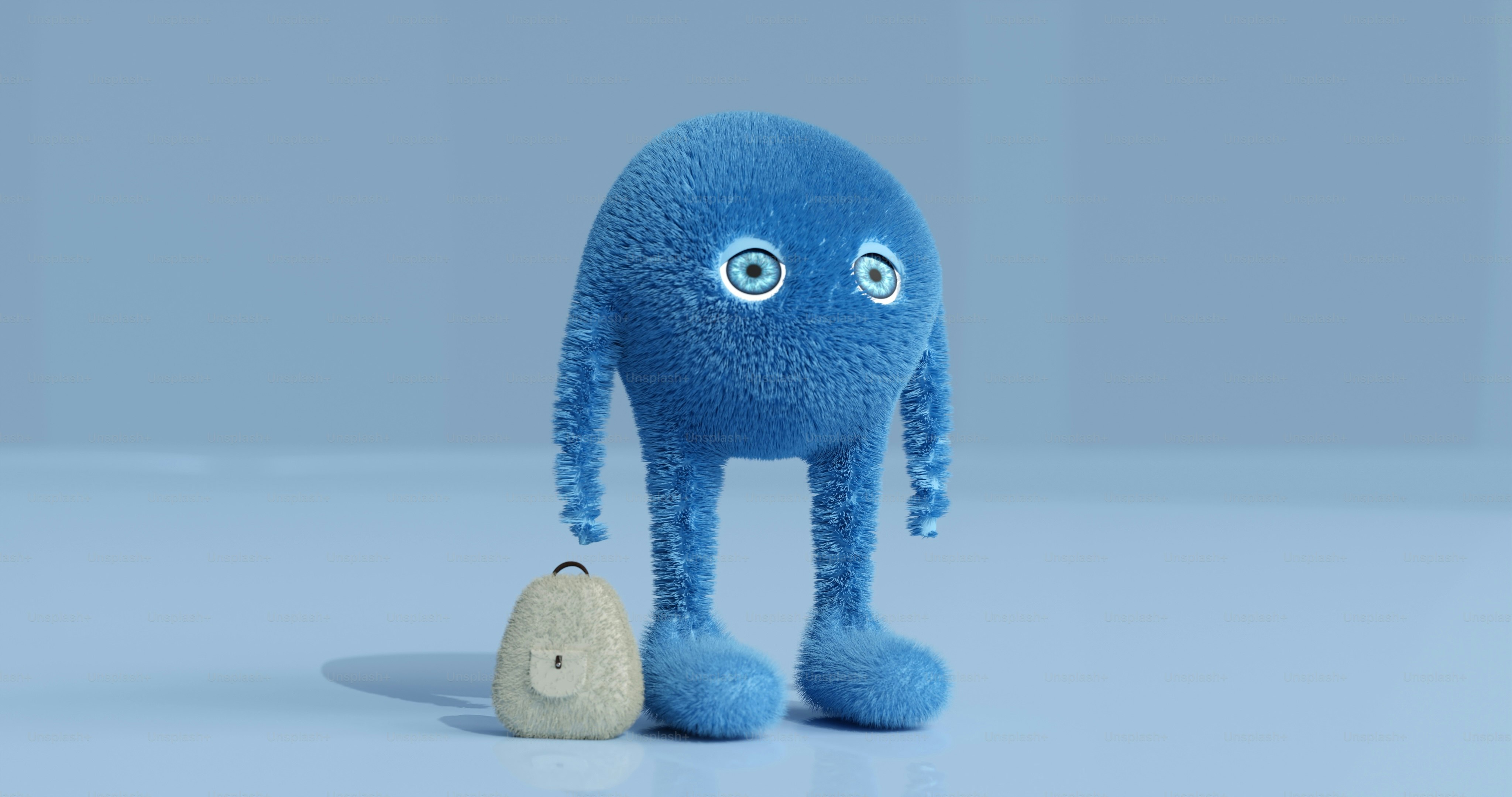 A blue stuffed animal standing next to a white object photo – Monster ...