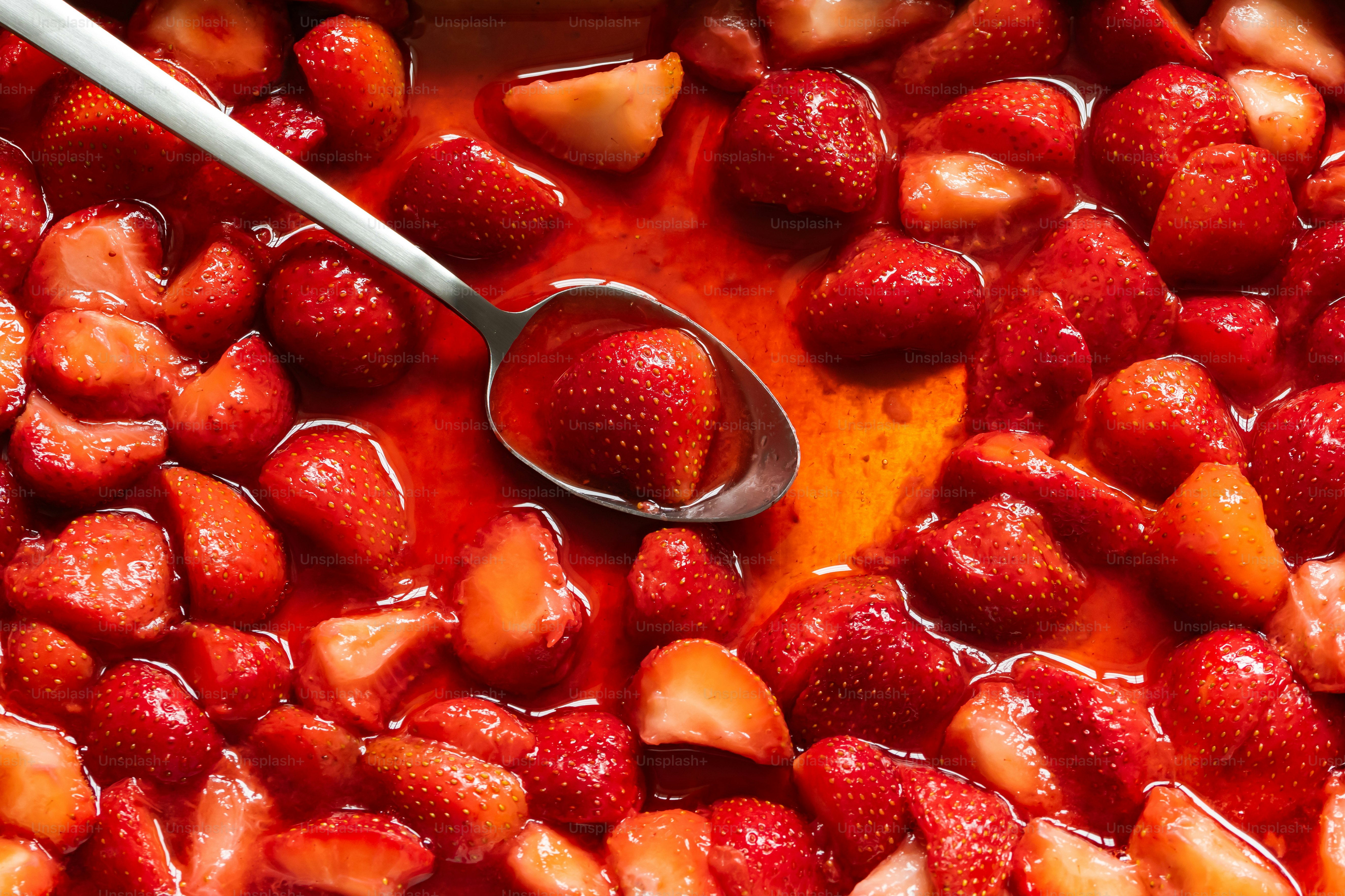 A bowl of strawberries with a spoon in it photo – Strawberries Image on ...
