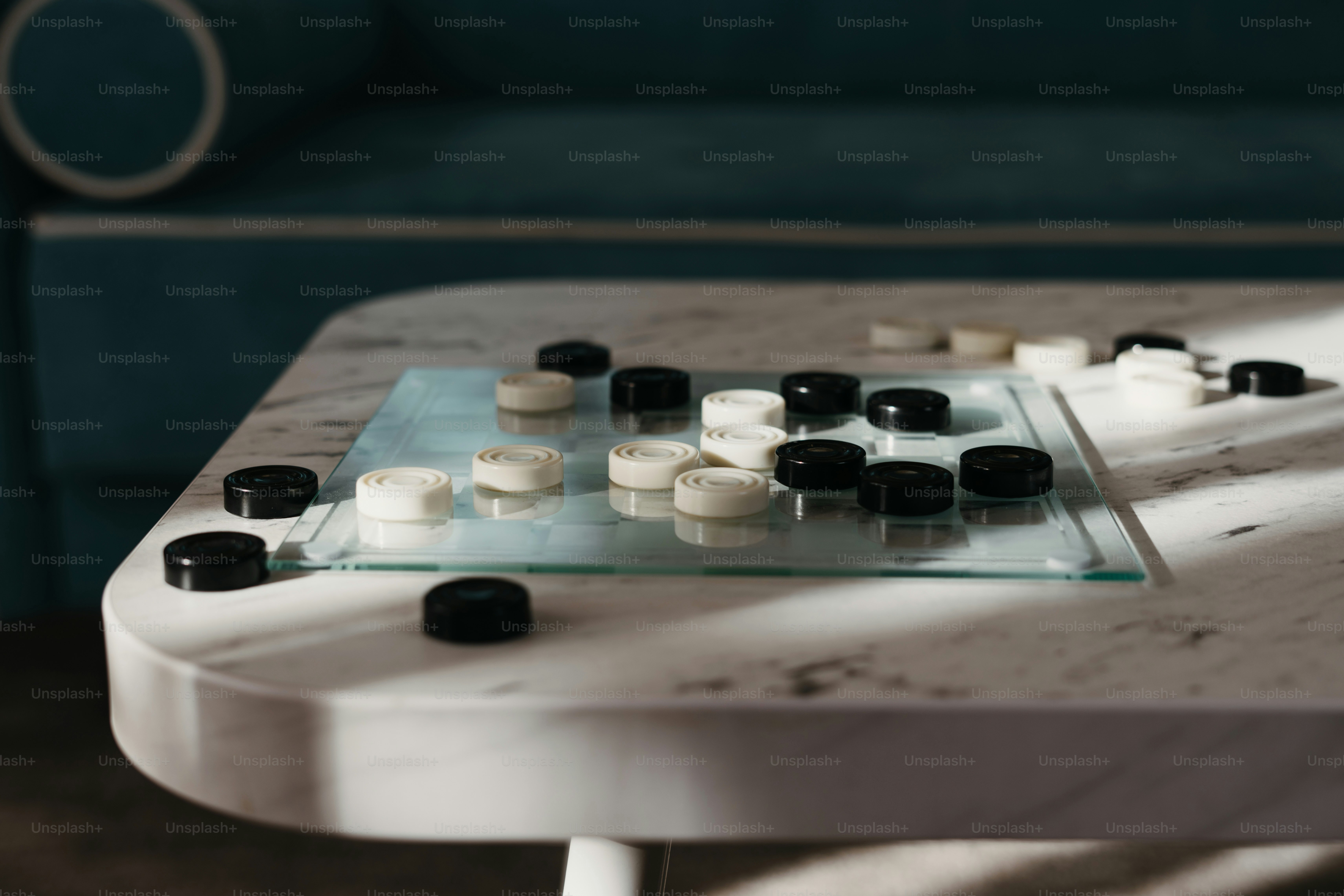 A game of checkers sitting on top of a table photo – Checkers Image on ...