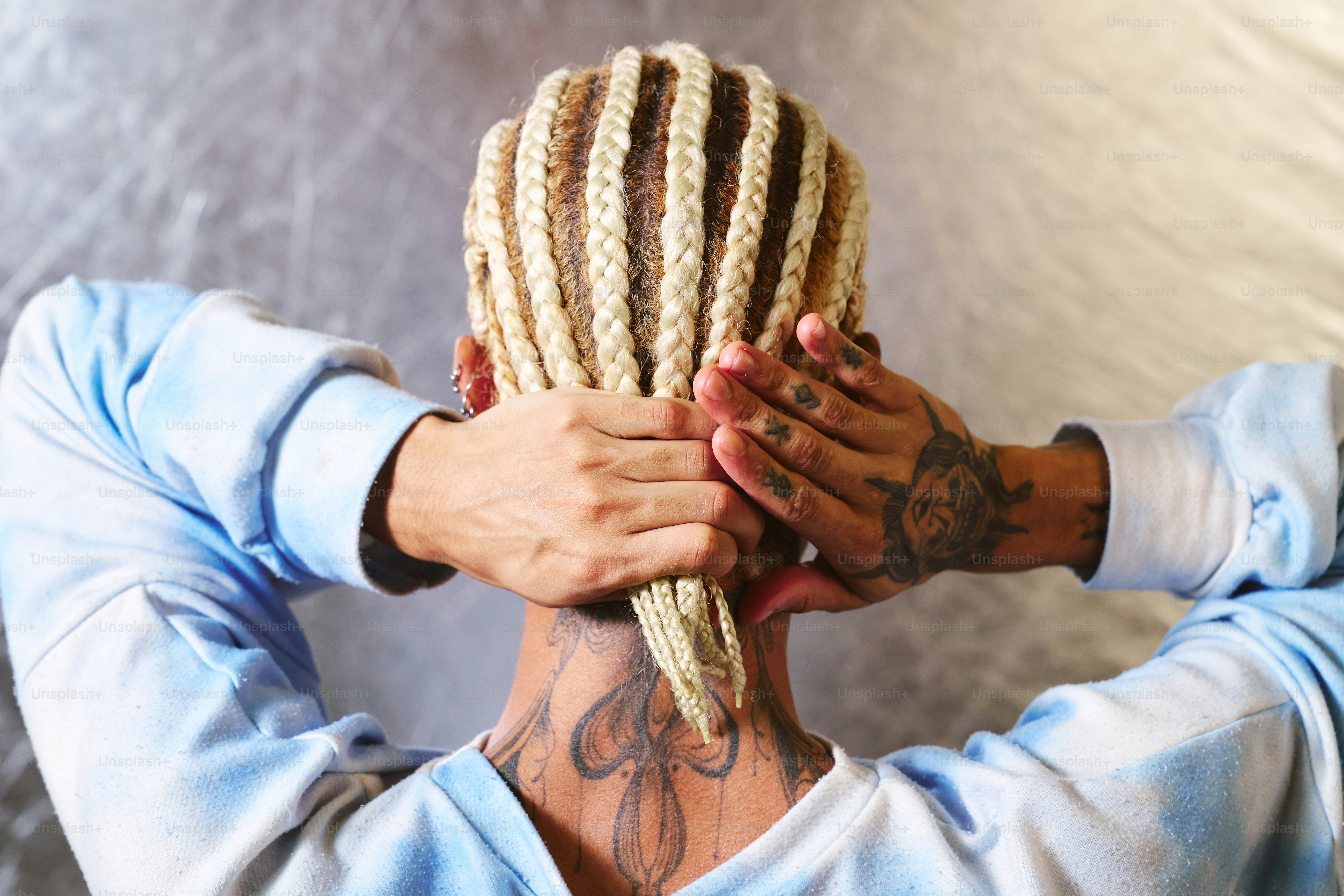 A man holding a rope wrapped around his head photo – Black Image on ...