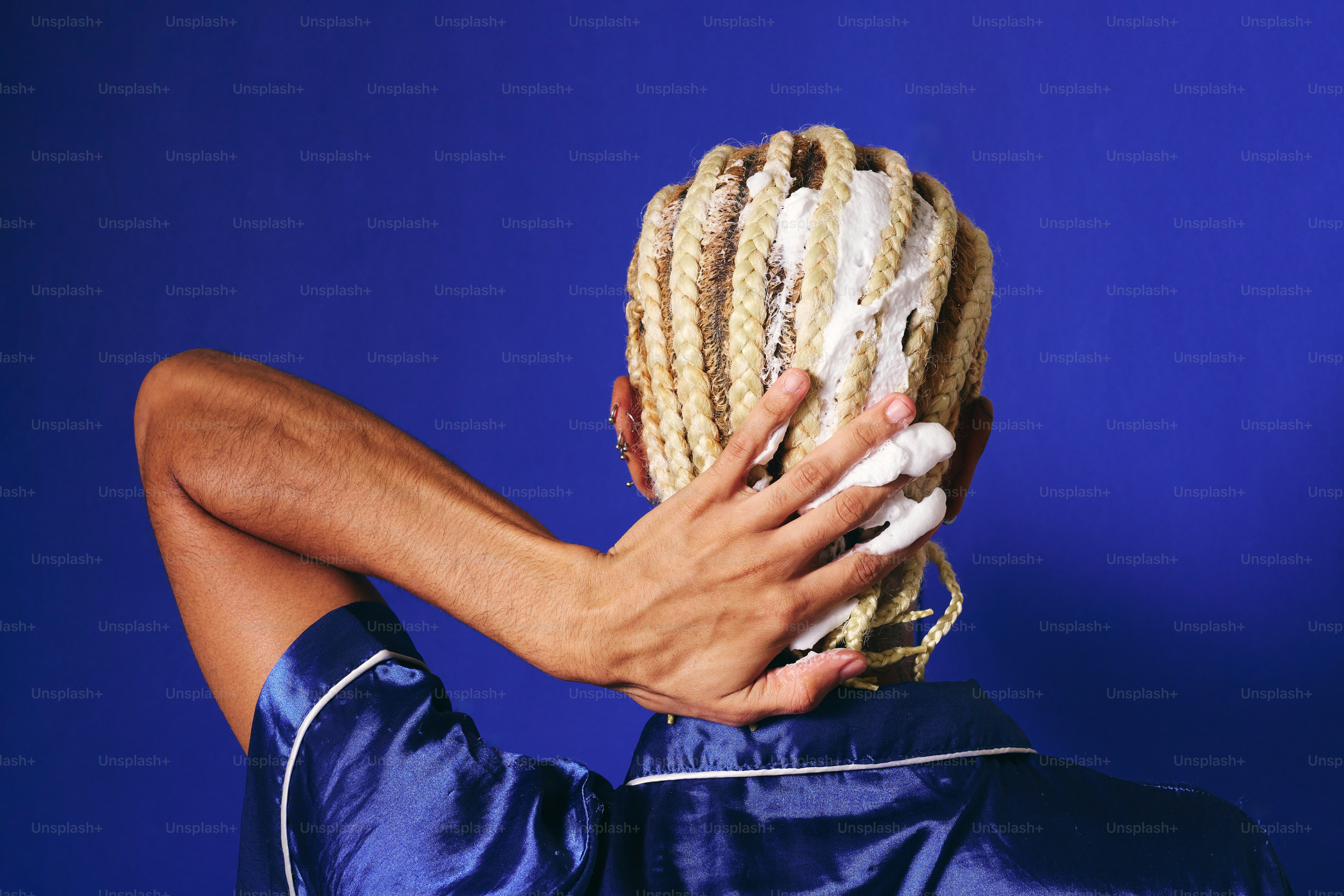 A man with dreadlocks covering his face with his hands photo – Artistic ...