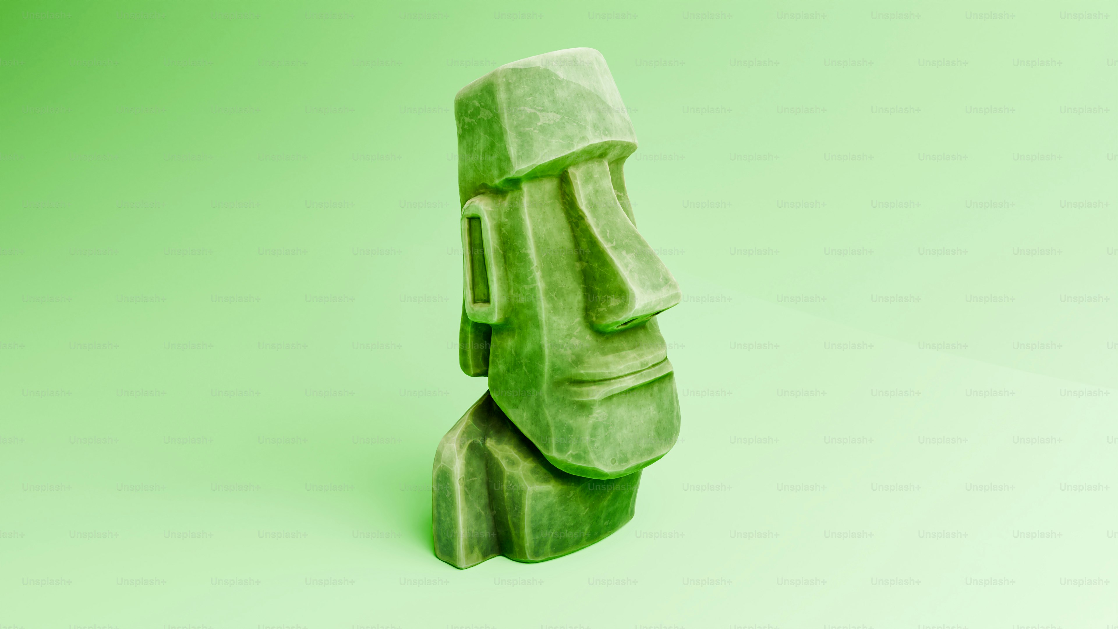 A green sculpture of a person on a green background photo – Moai Image ...