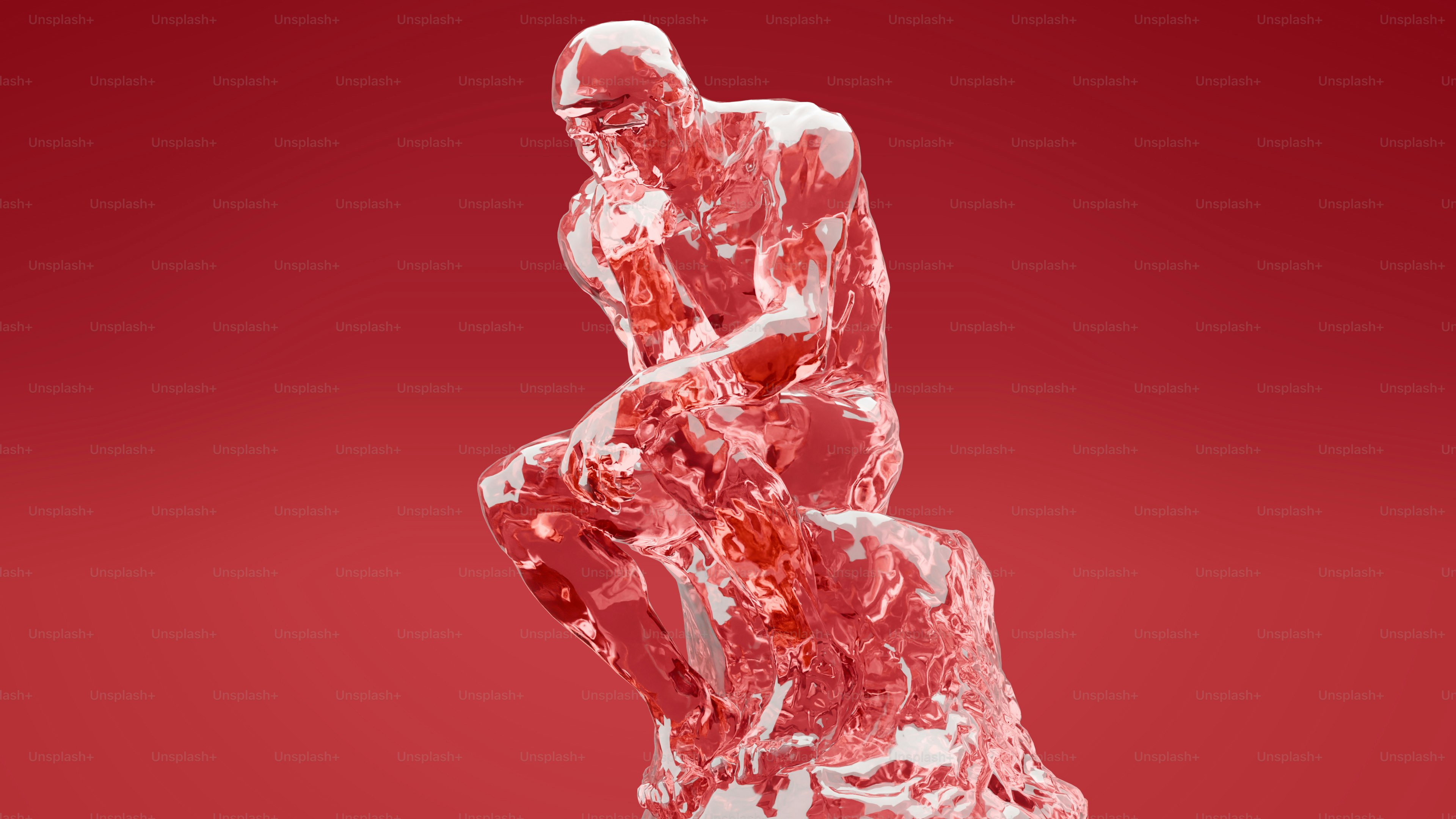 A glass figurine of a man on a red background photo – The thinker Image ...
