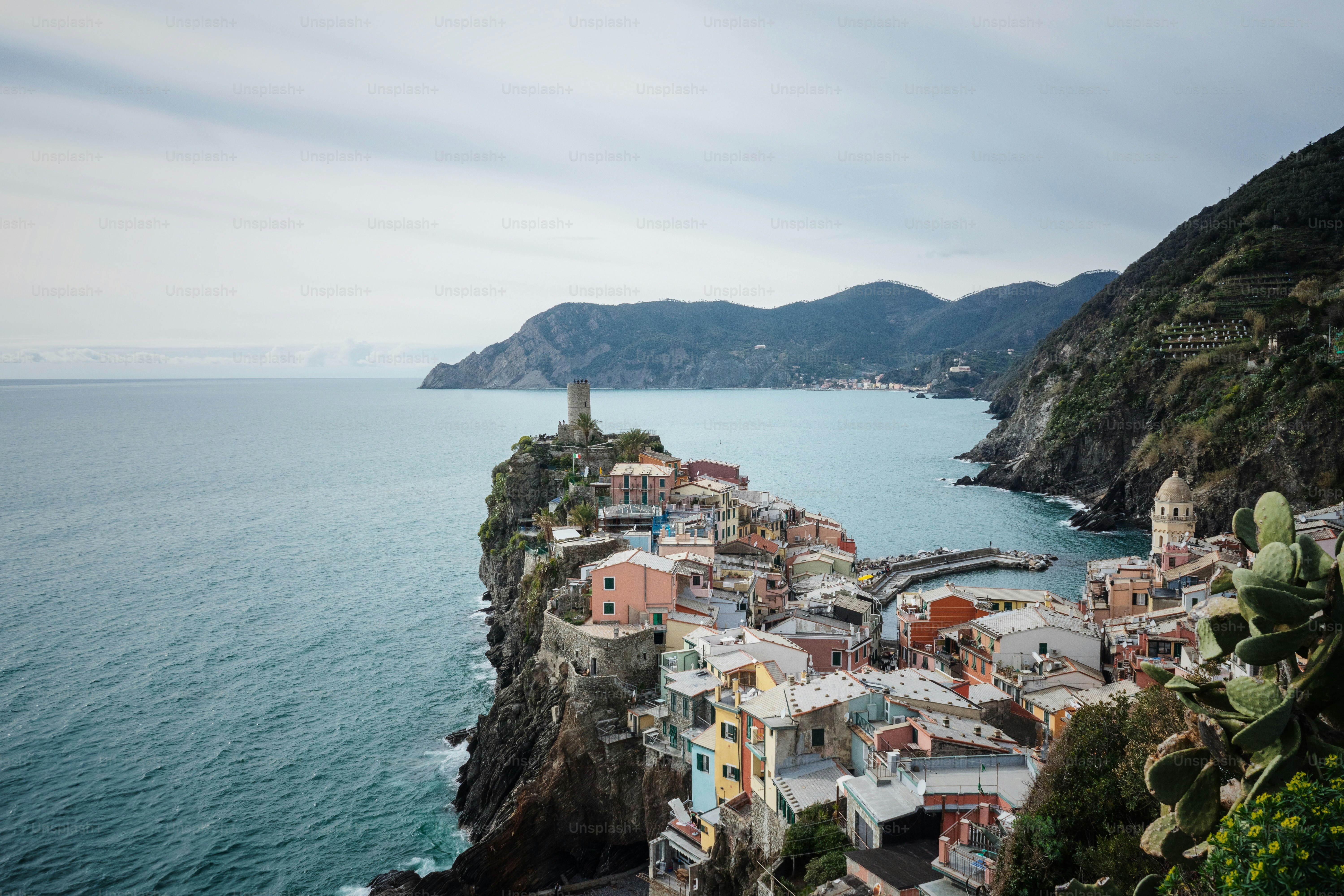 A small village on a cliff overlooking the ocean photo – Italia Image ...