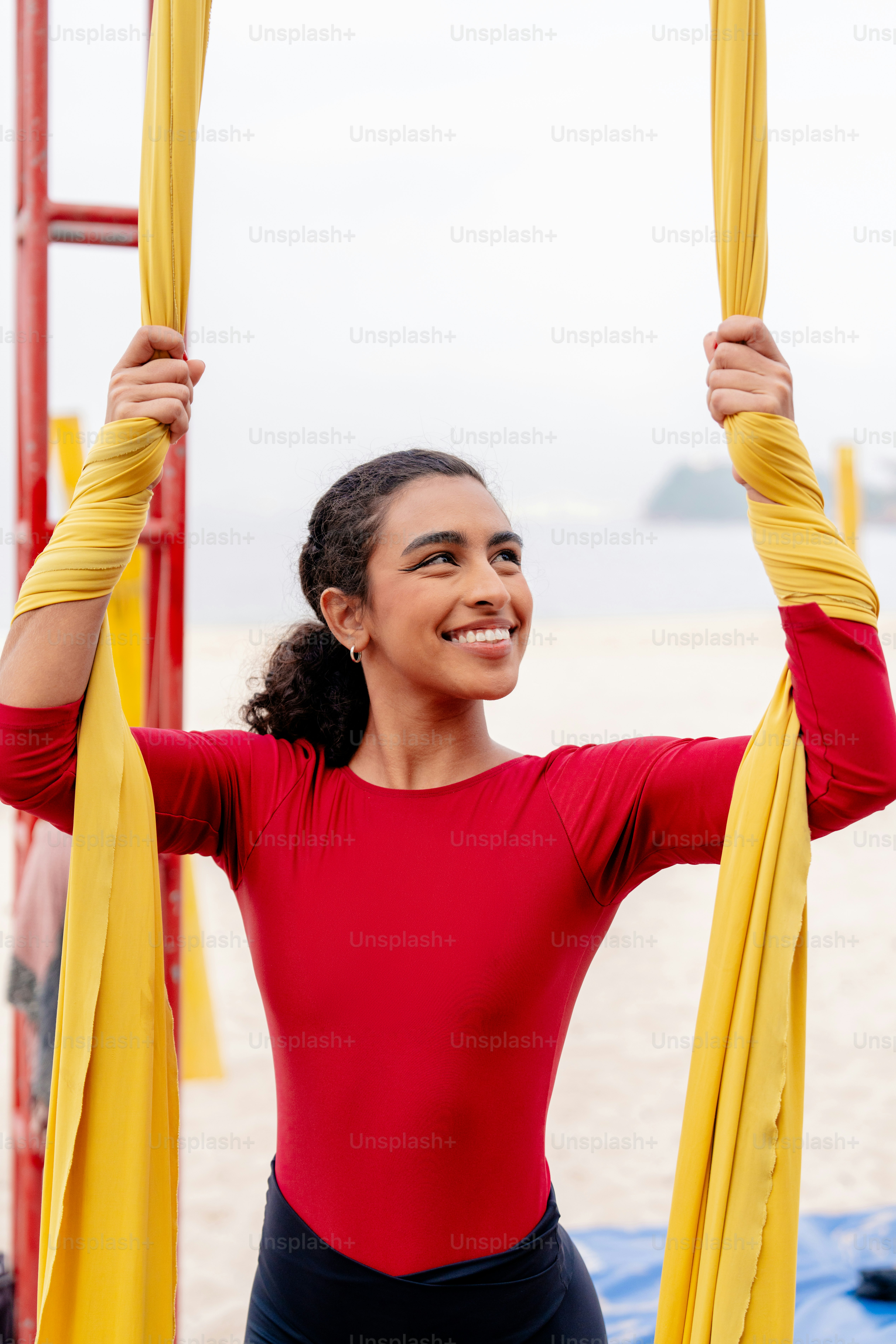 A woman holding a pair of yellow ropes in front of her face photo ...
