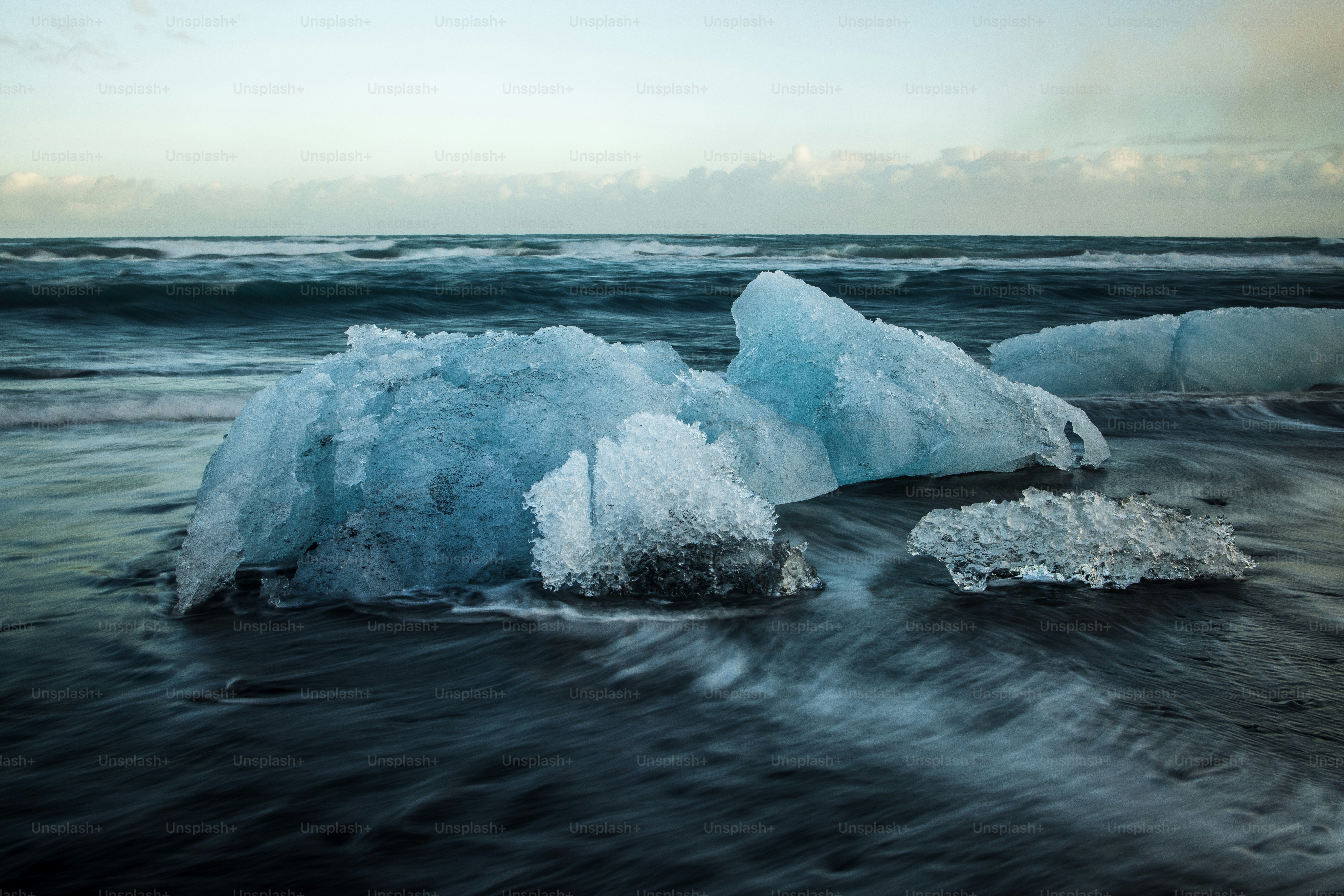 A group of icebergs floating on top of a body of water photo – Iceland ...