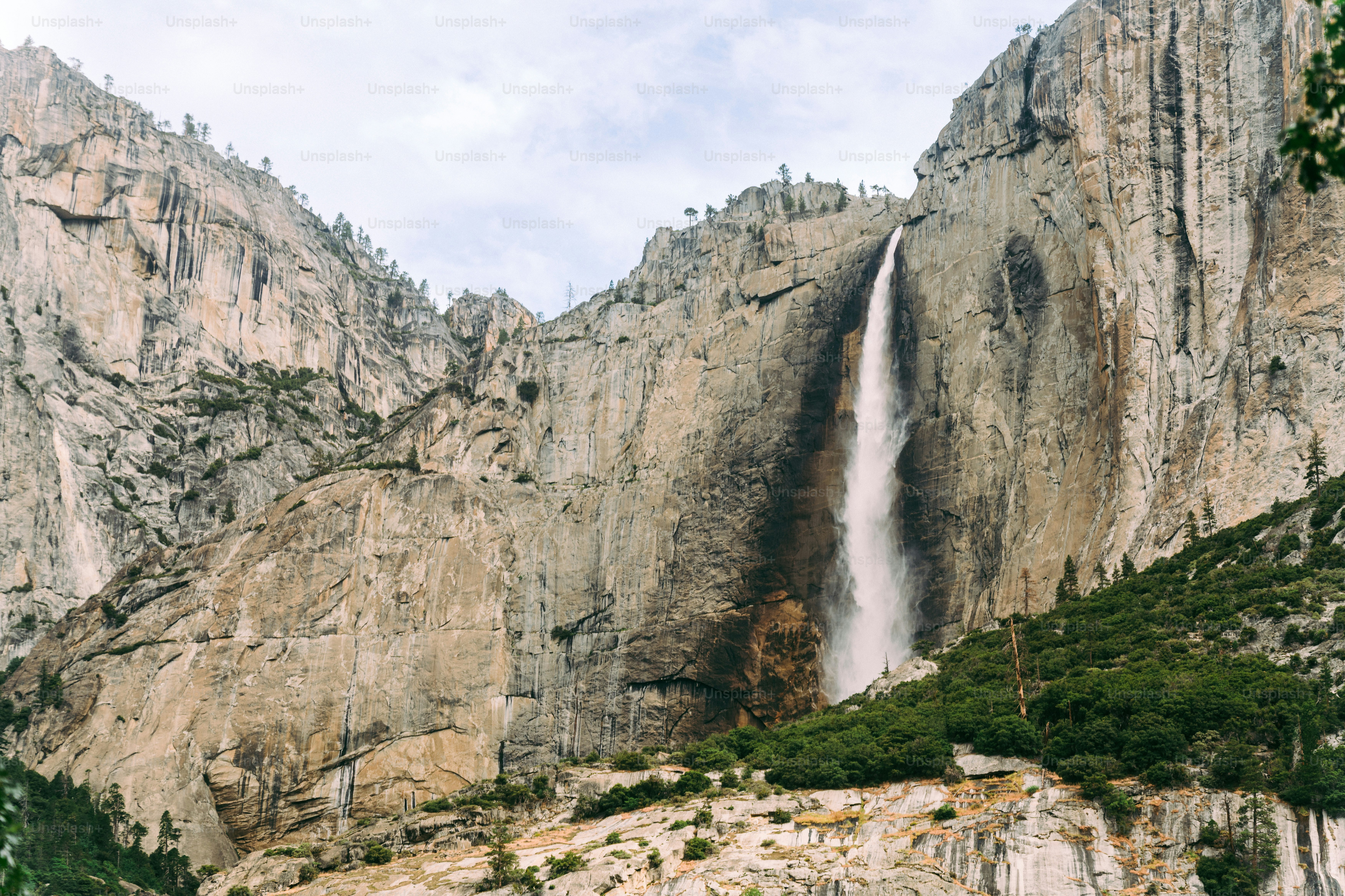 A very tall waterfall in the middle of a mountain photo – Usa Image on ...