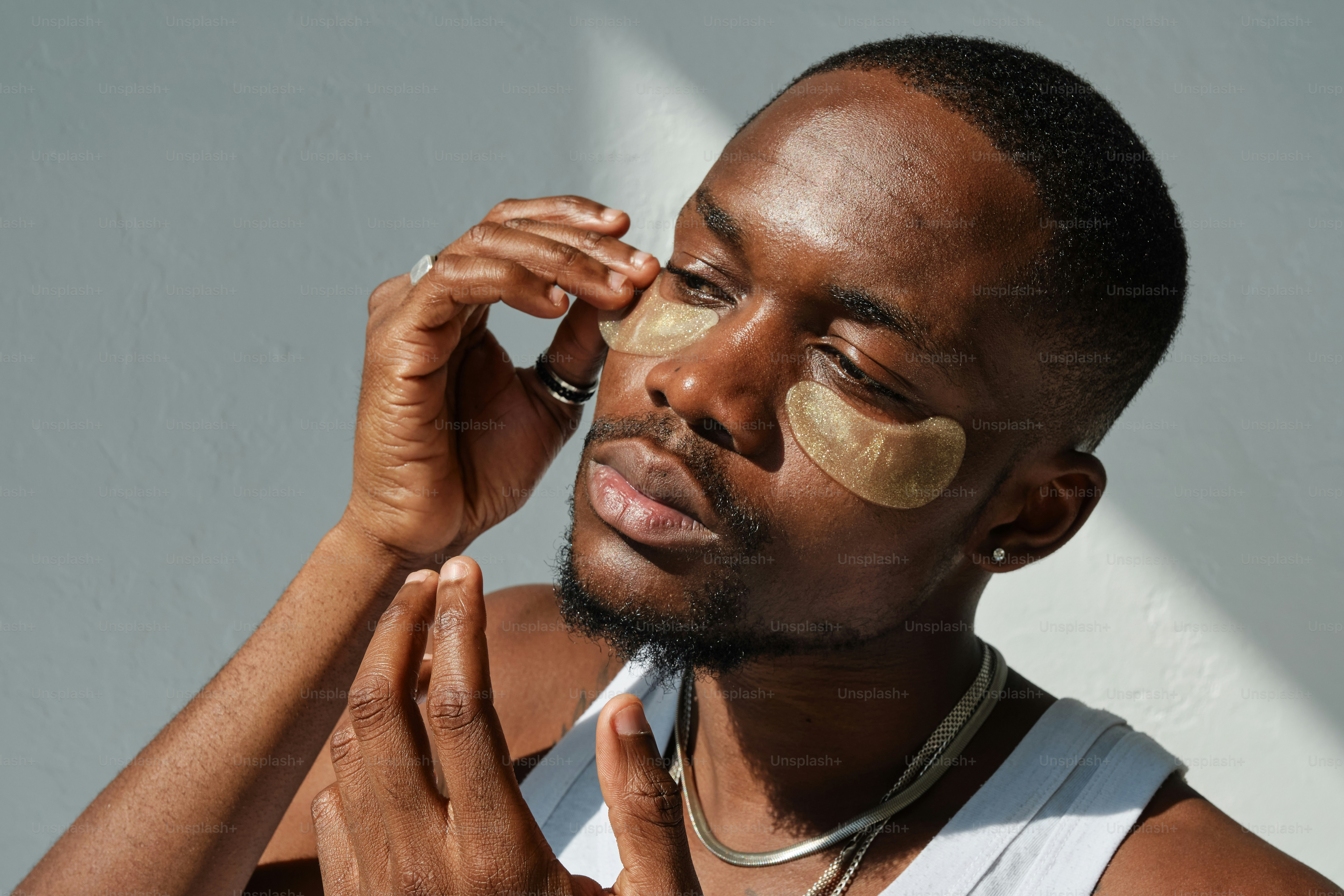 A man with a gold eye patch on his face photo – Black Image on Unsplash