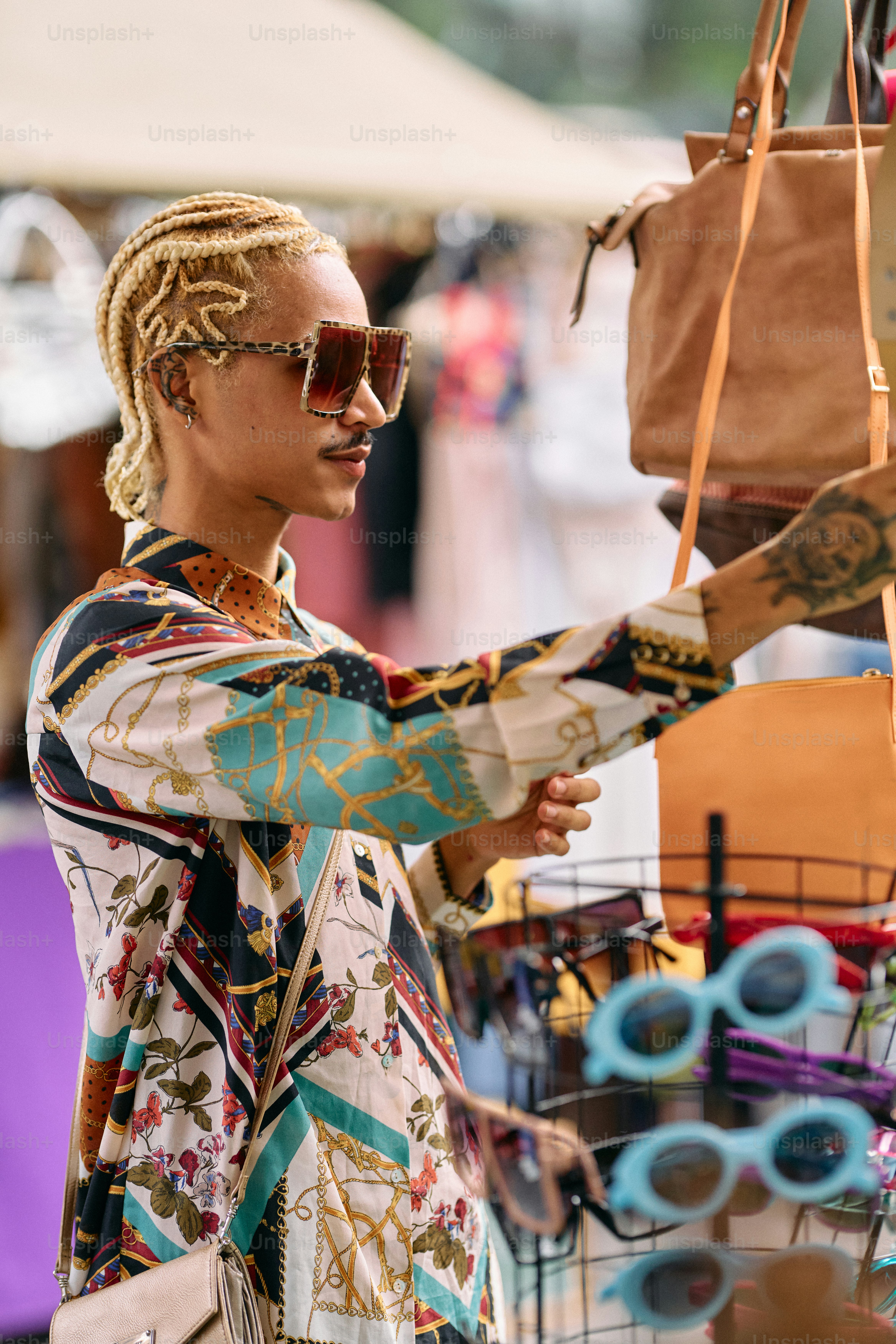 A woman with dreadlocks shopping at an outdoor market photo – Black ...