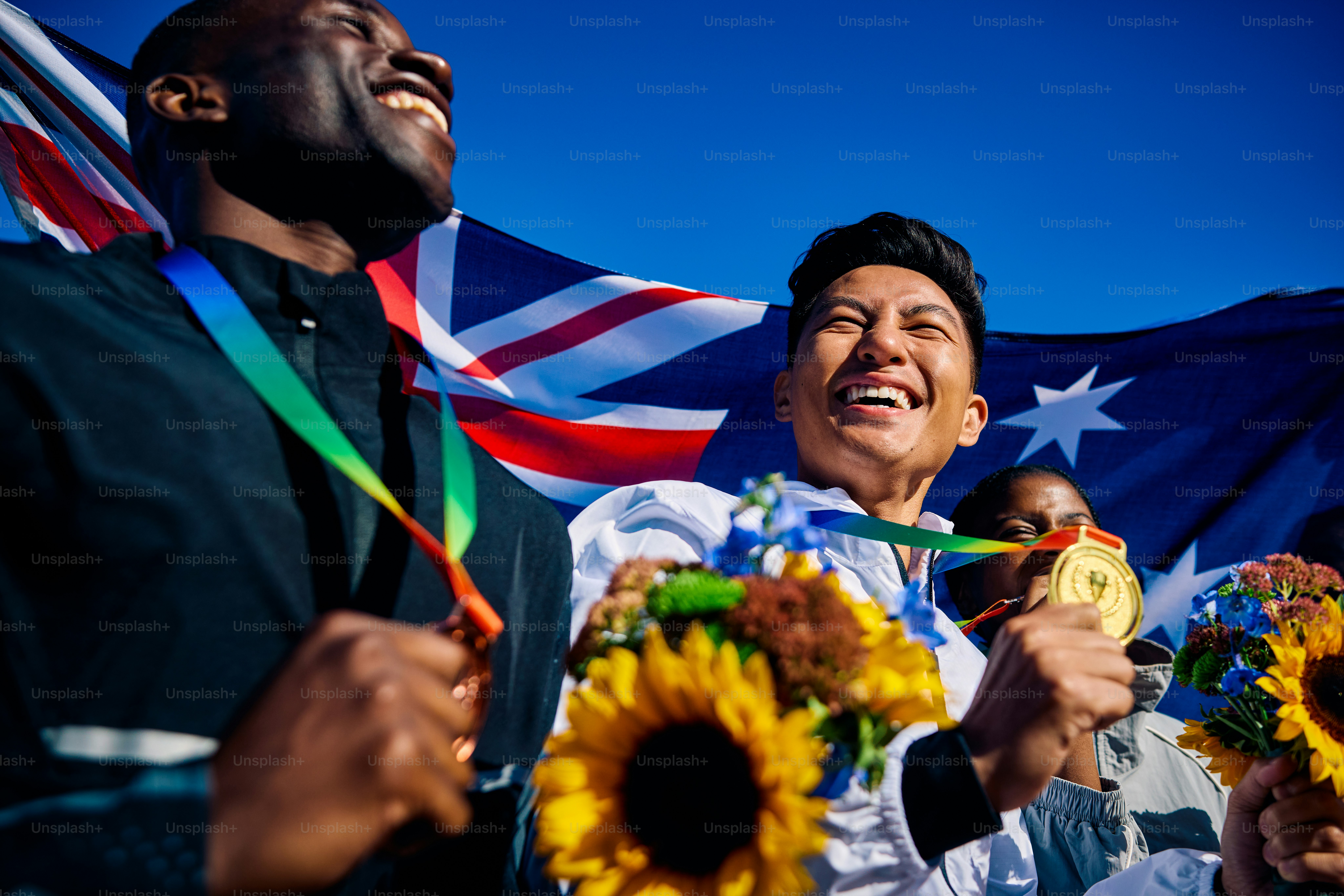 Ecstatic Australian athletes with medals and bouquets against the ...