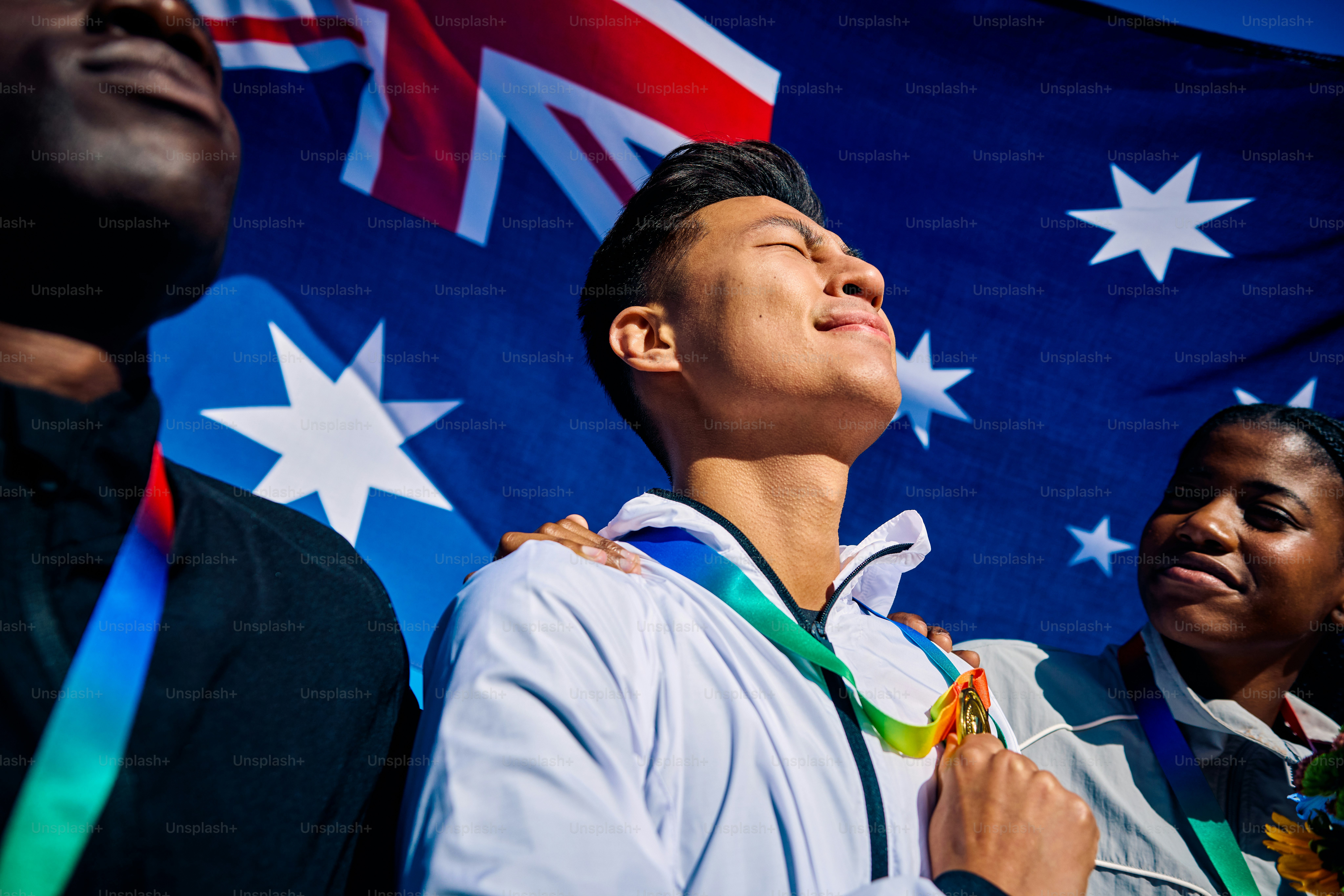 Ecstatic Australian athletes with medals and bouquets against the ...