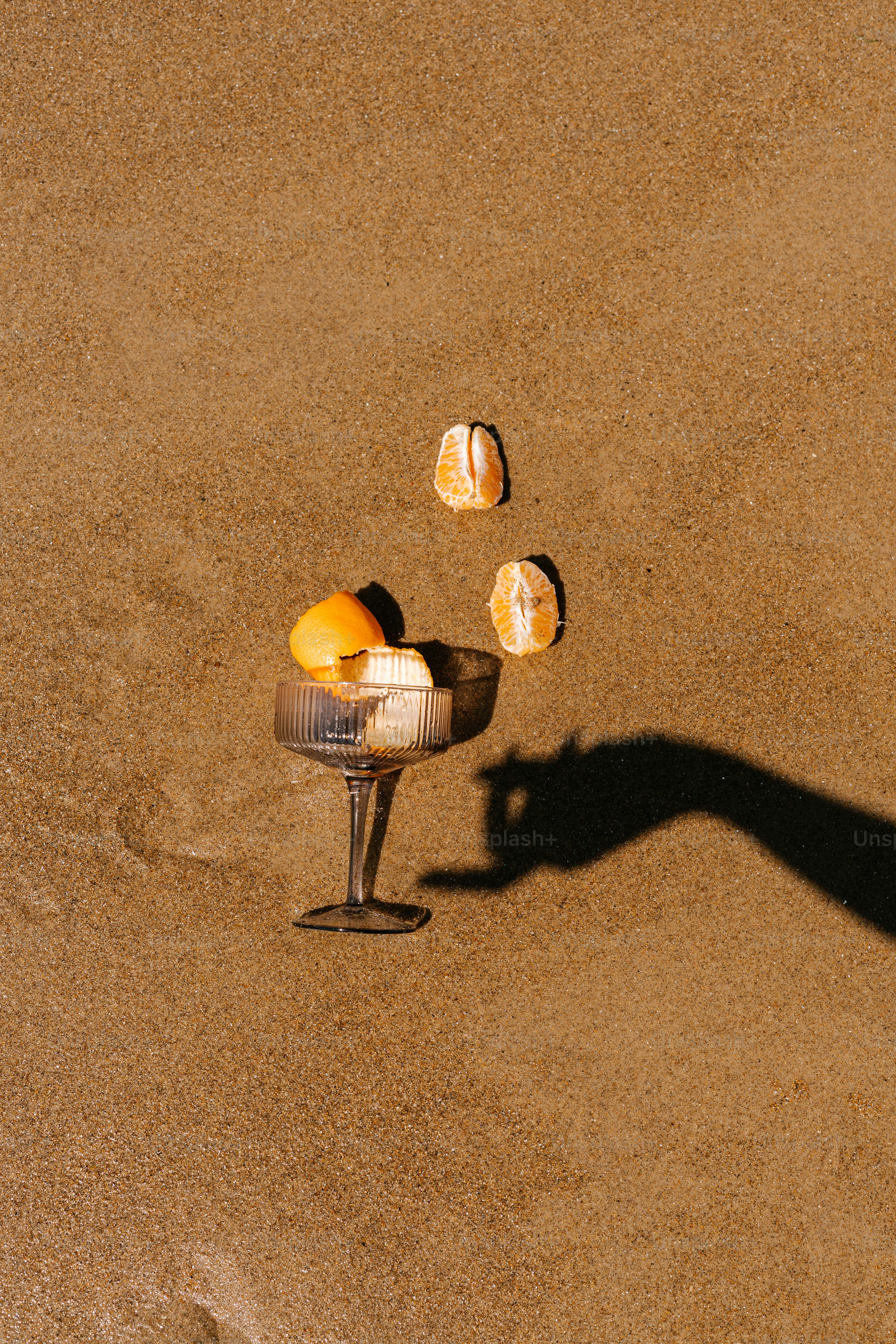 A shadow of a person casting a shadow on the sand photo – Shadow play ...