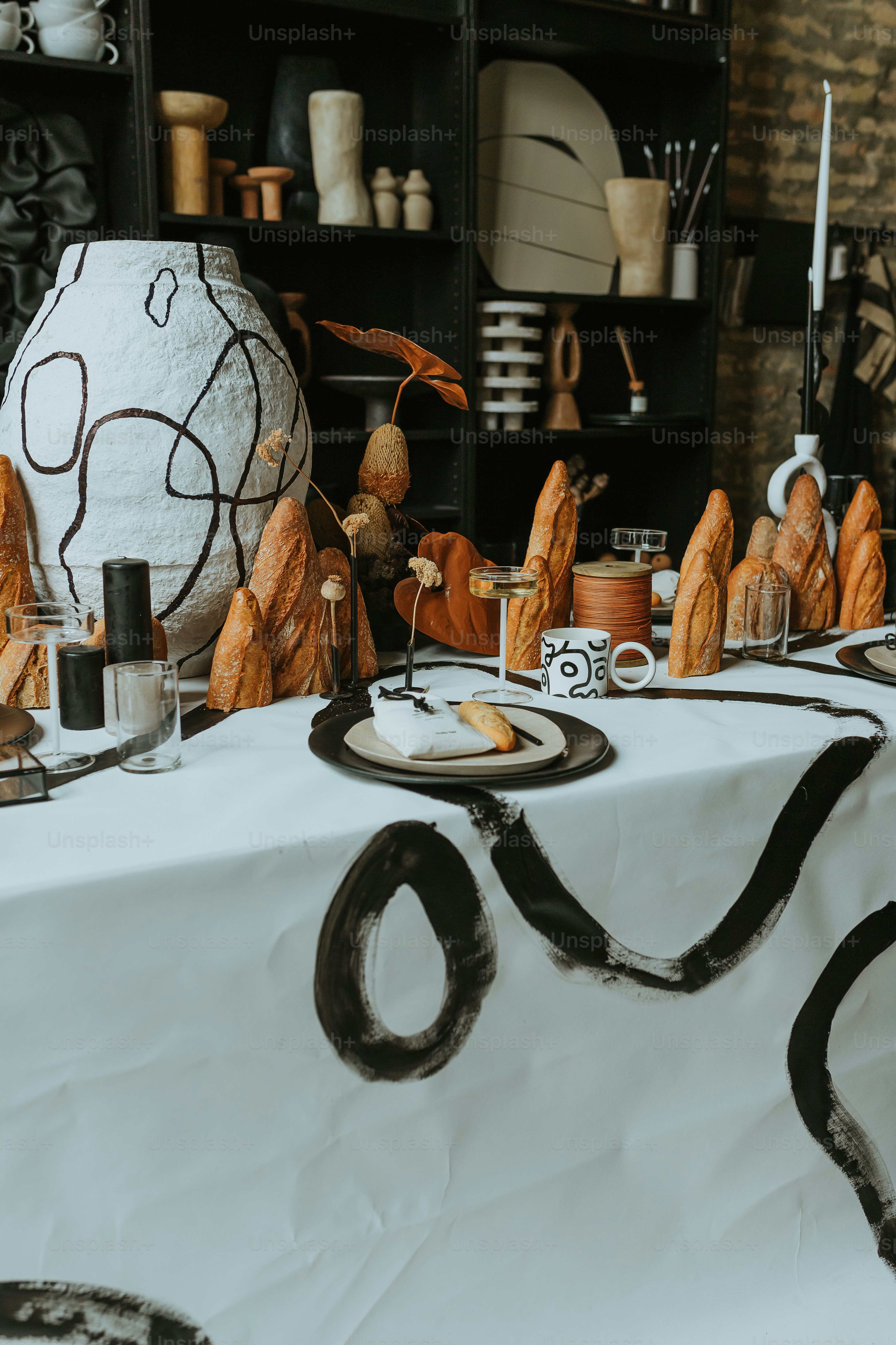 A table topped with lots of different types of bread photo – Tablescape ...
