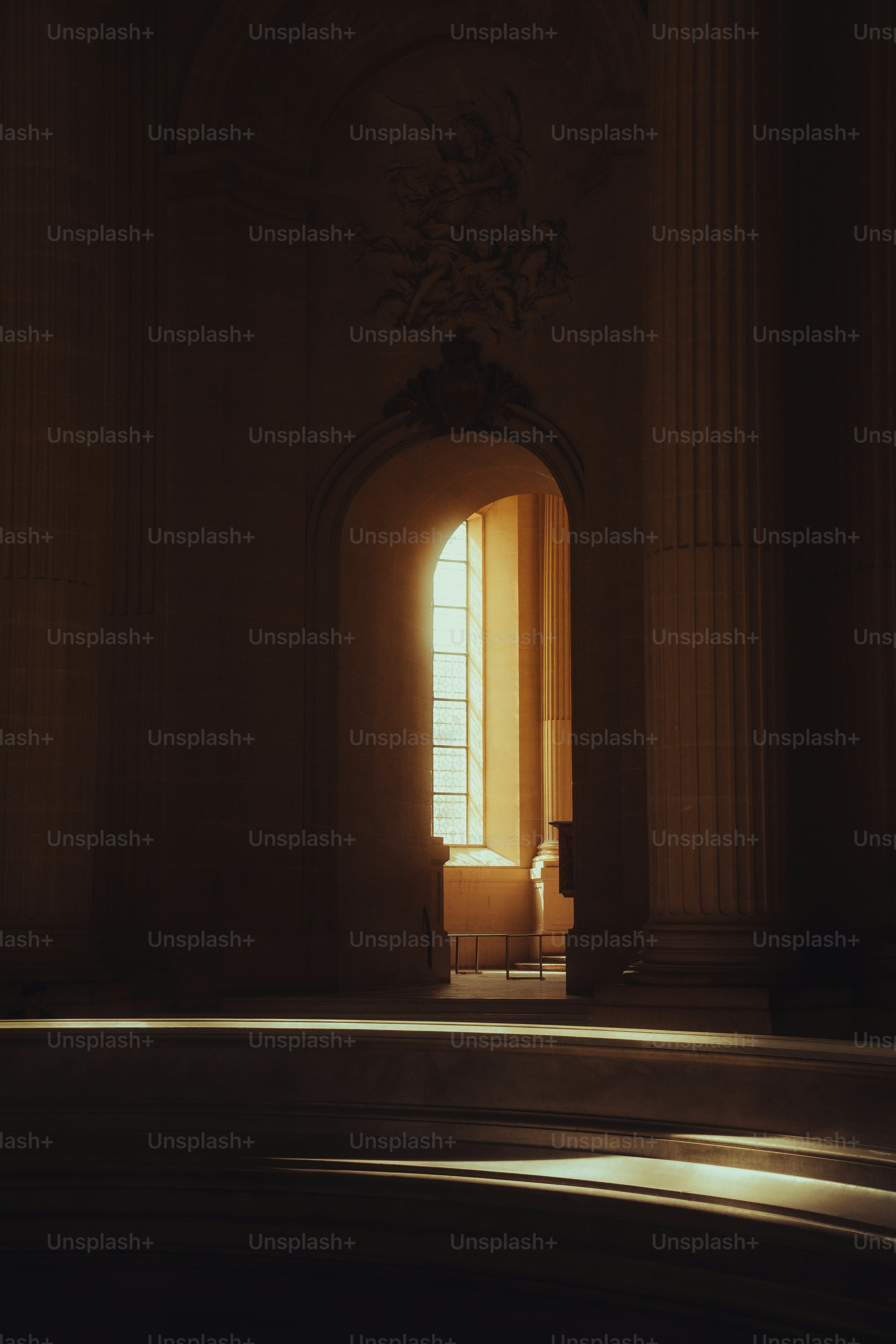 A light shines through a window in a building photo – Light Image on ...