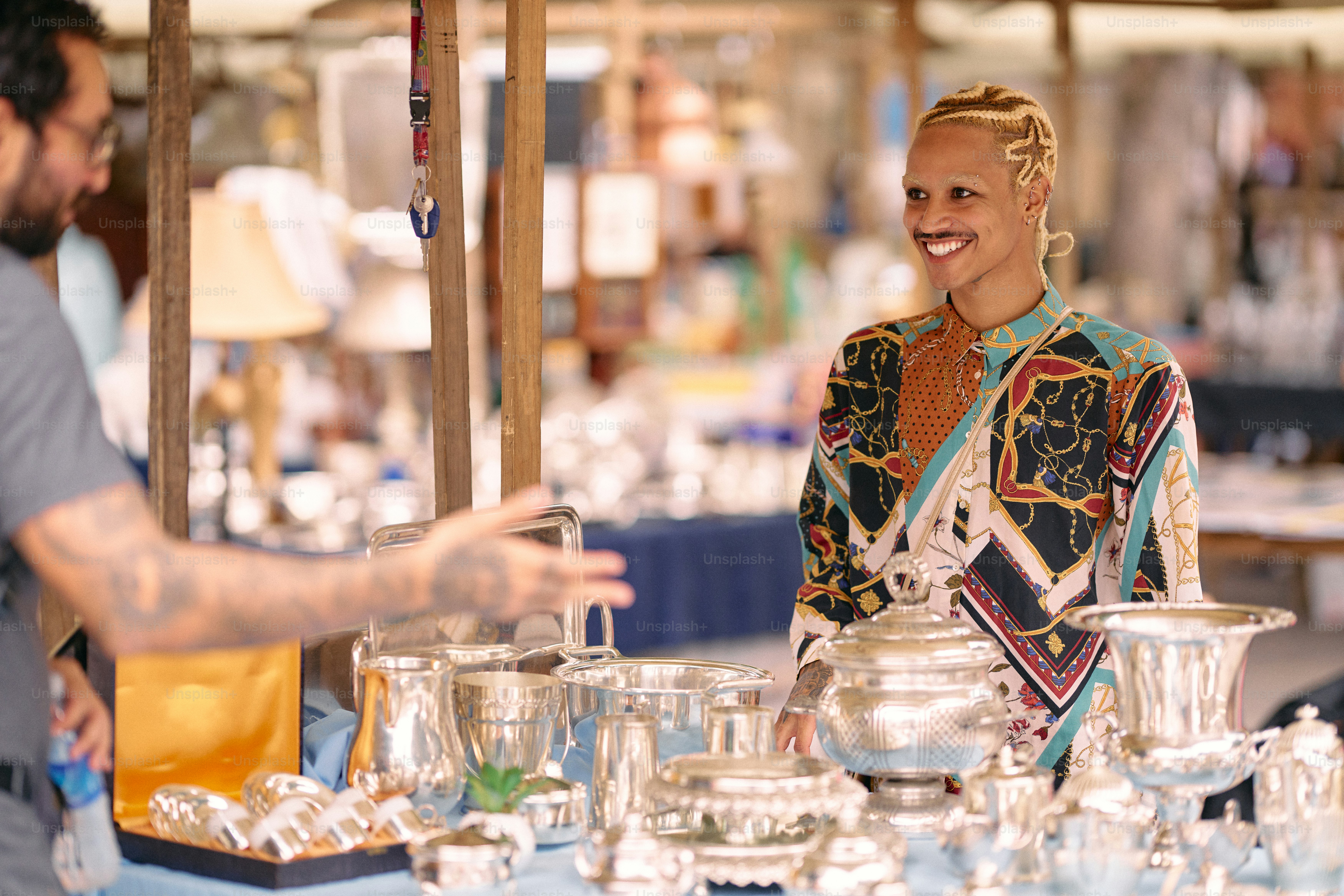 A woman standing in front of a table filled with silverware photo ...