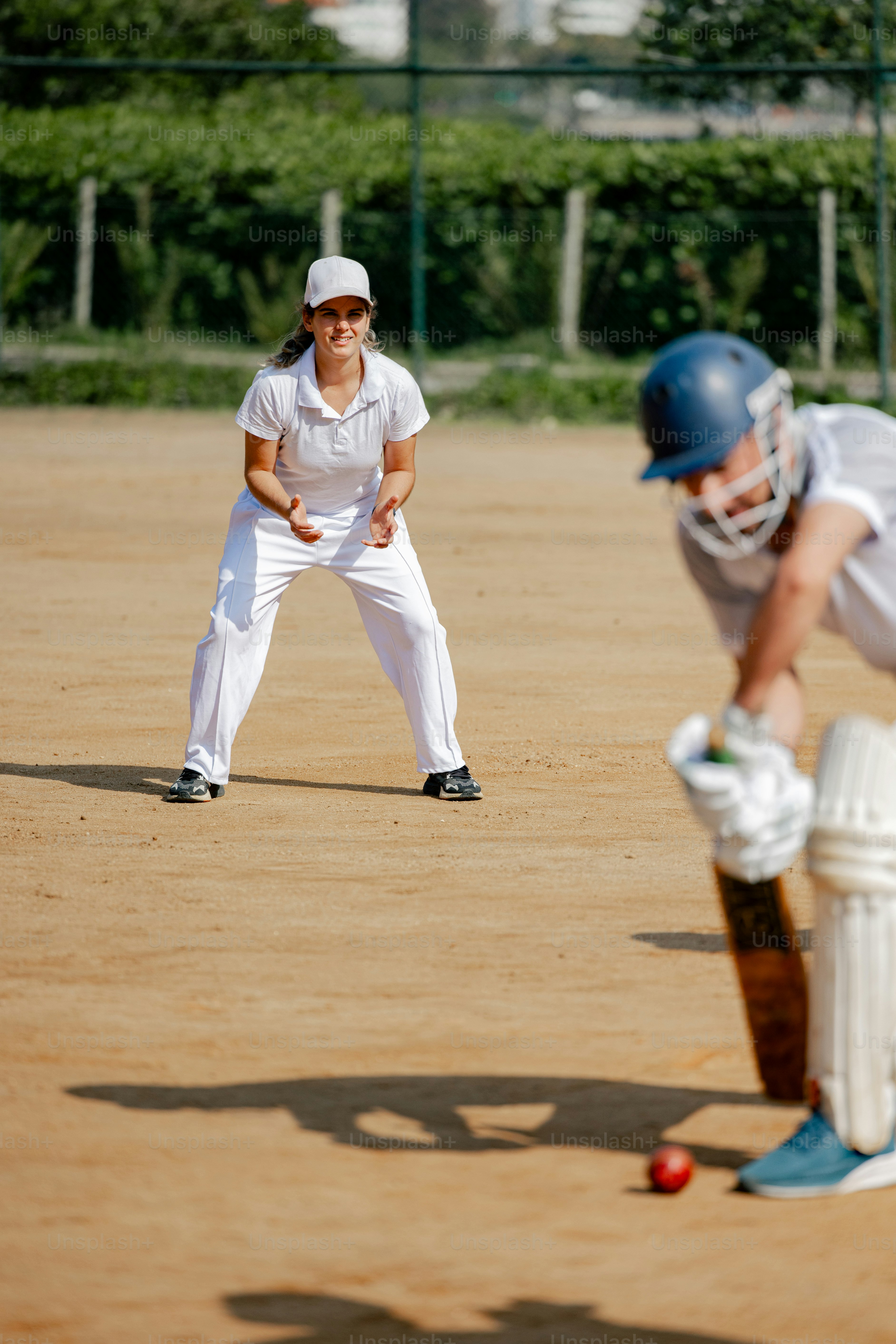 Two men playing a game of cricket on a field photo – Training Image on ...