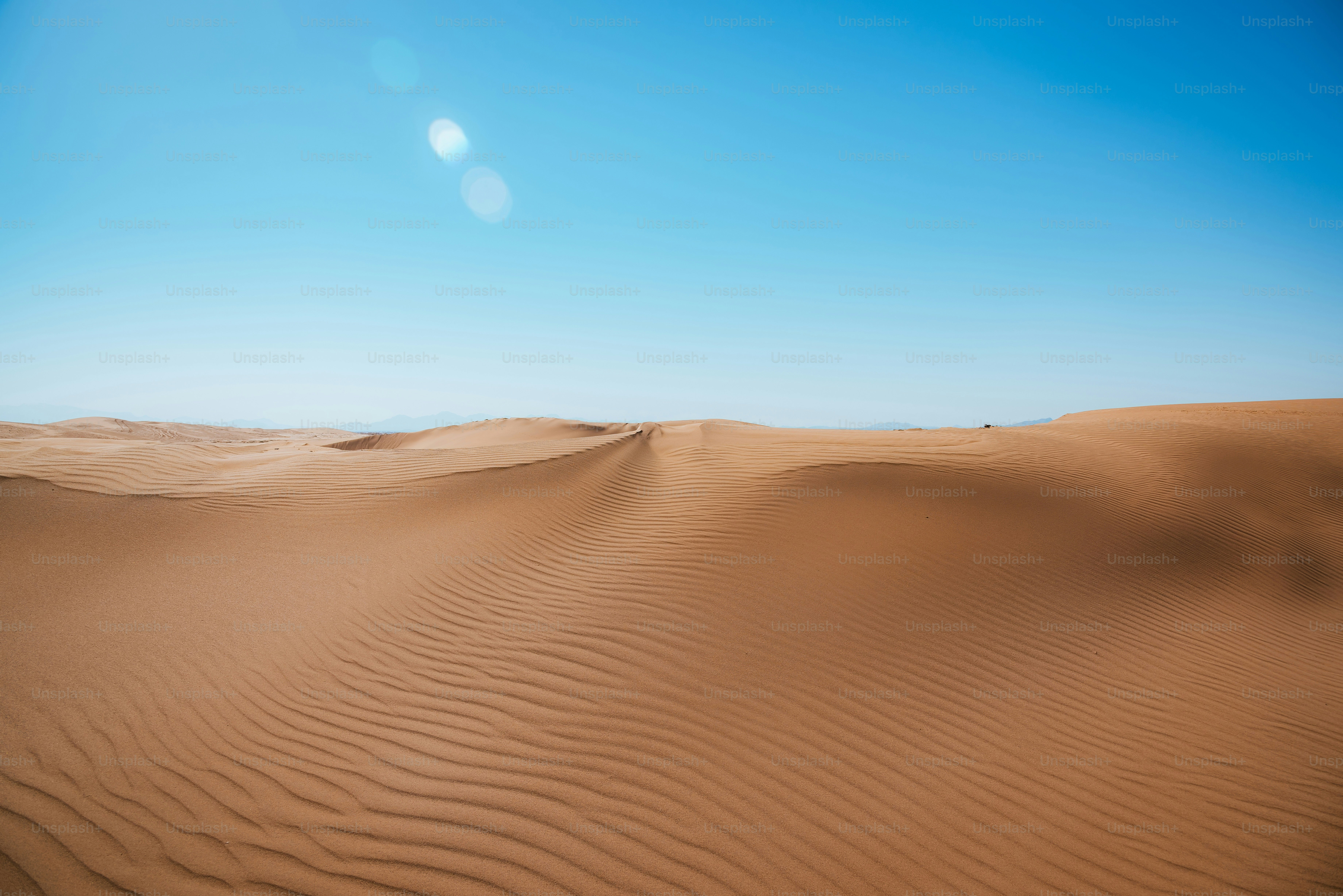 A desert scene with a blue sky and some sand dunes photo – Dunes Image ...