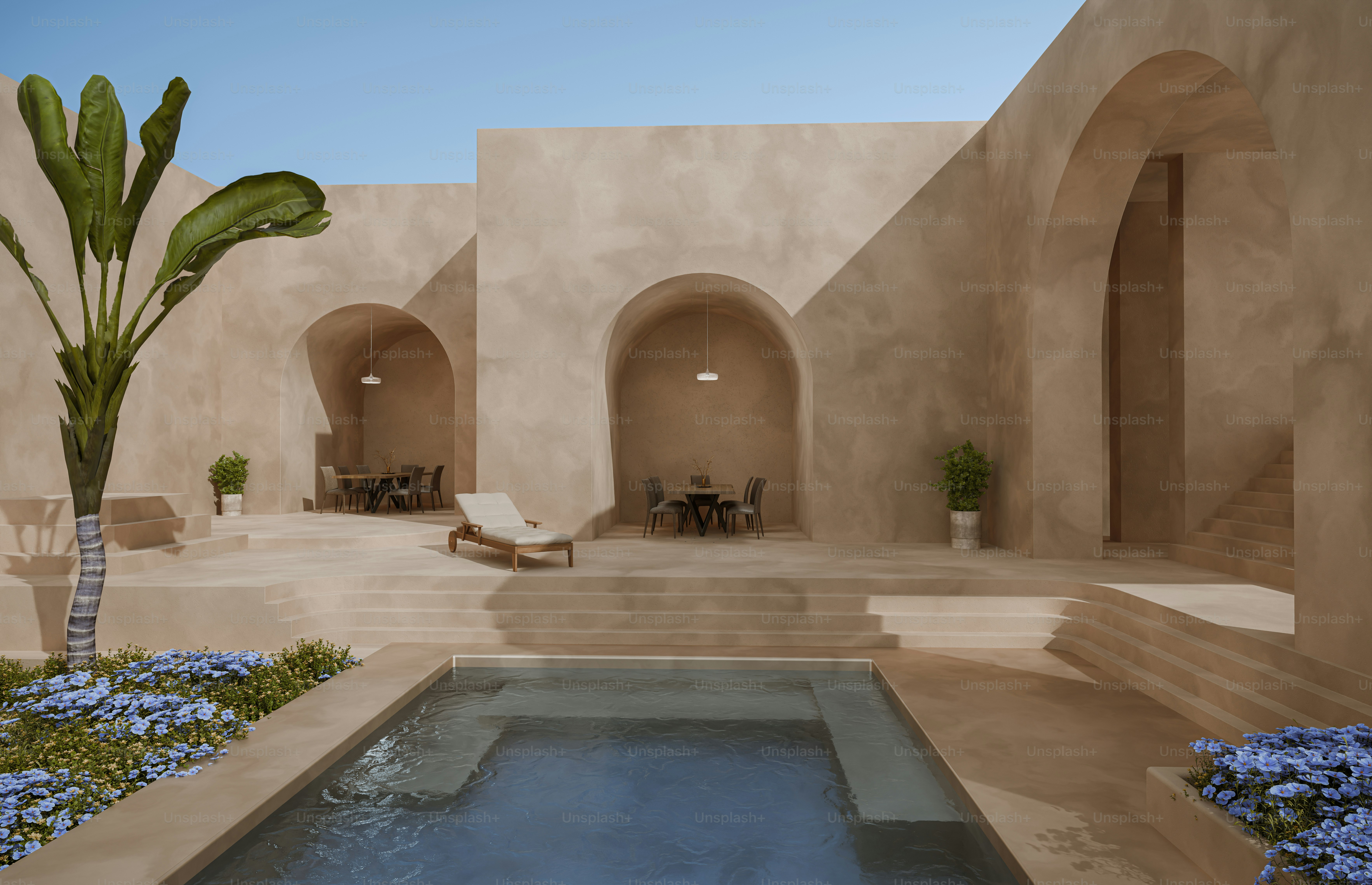 A courtyard with a pool surrounded by blue flowers photo – Palm tree ...