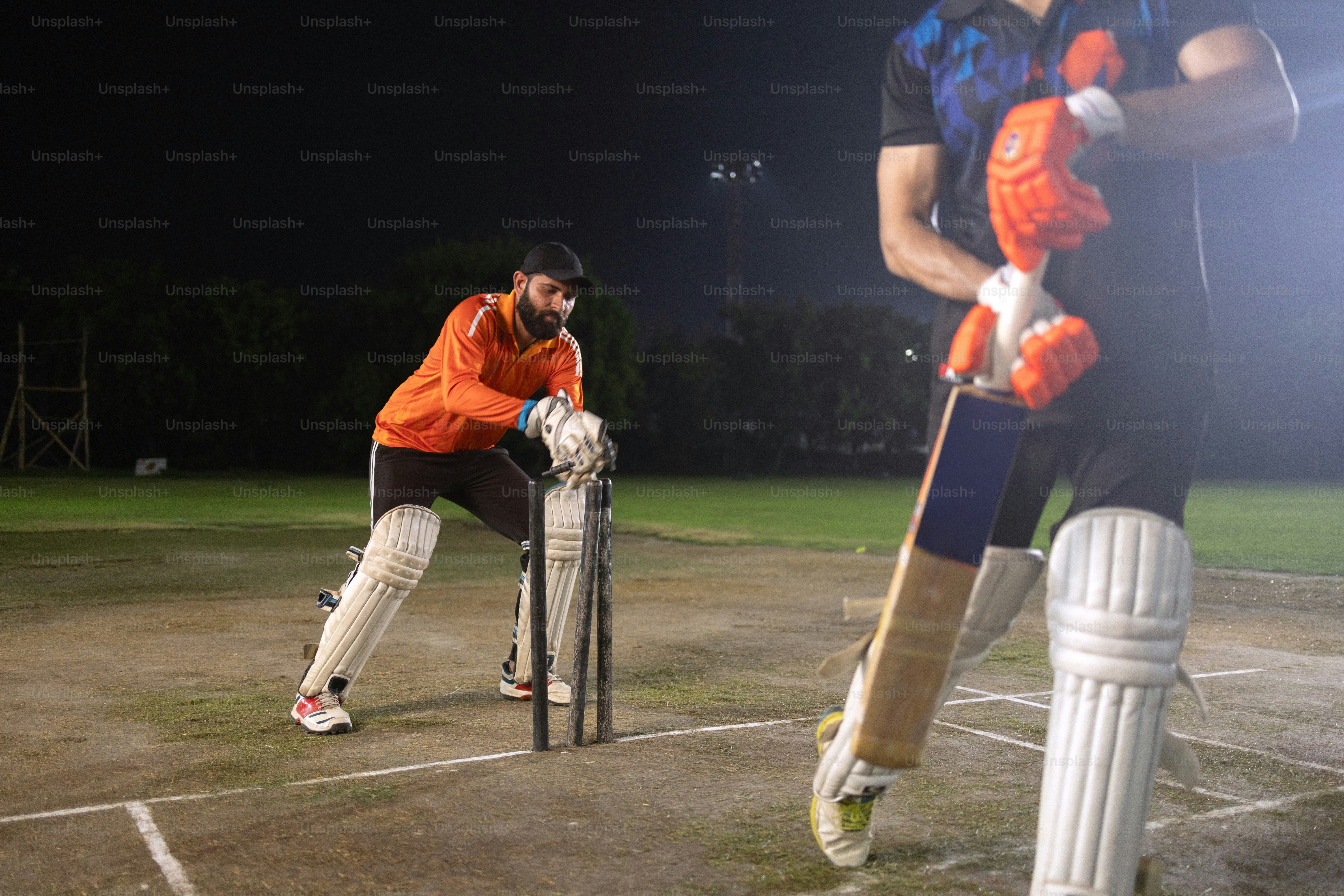 Two men playing a game of cricket at night photo – Sport Image on Unsplash