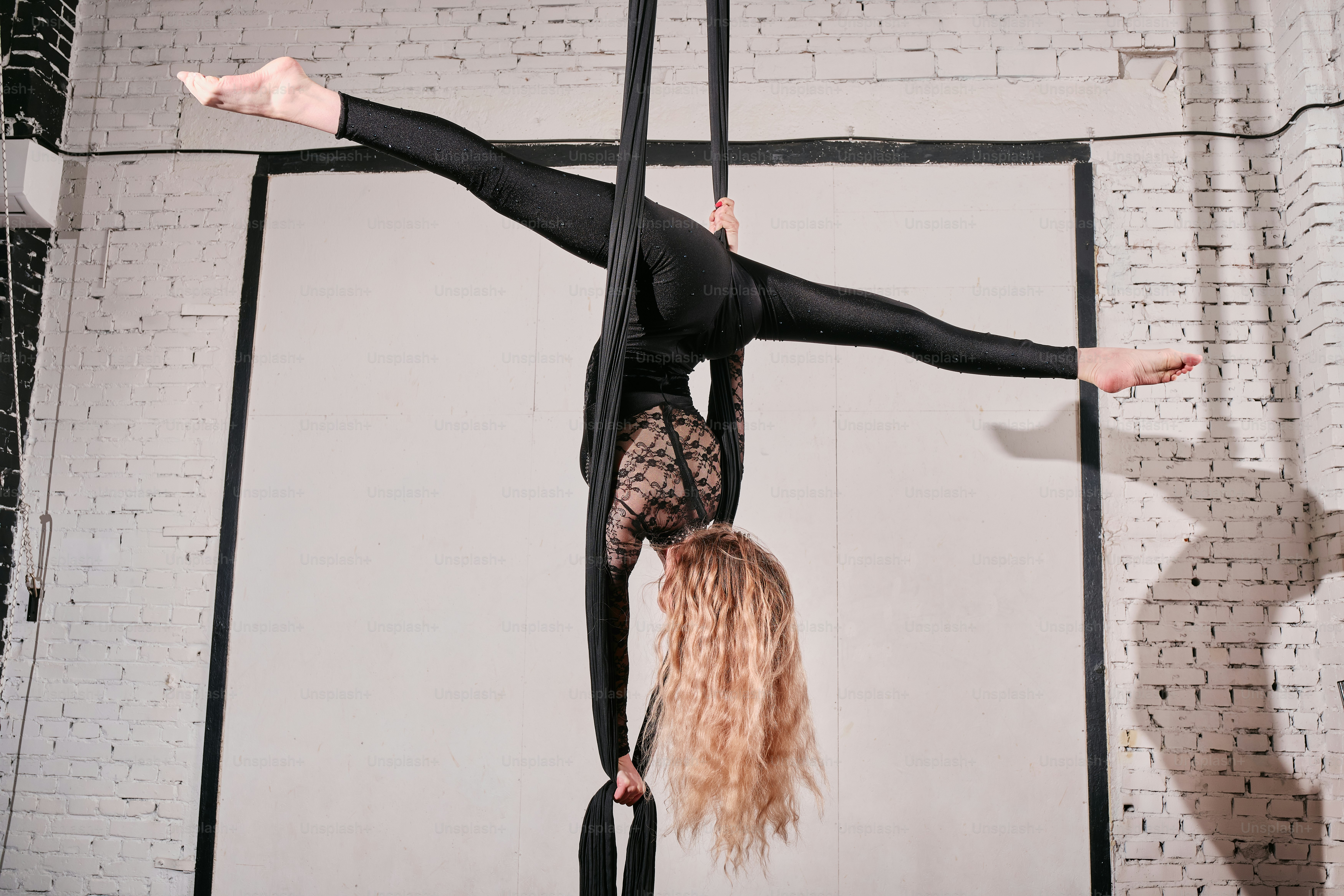 A woman is doing a handstand on a cross photo – Performance Image on ...