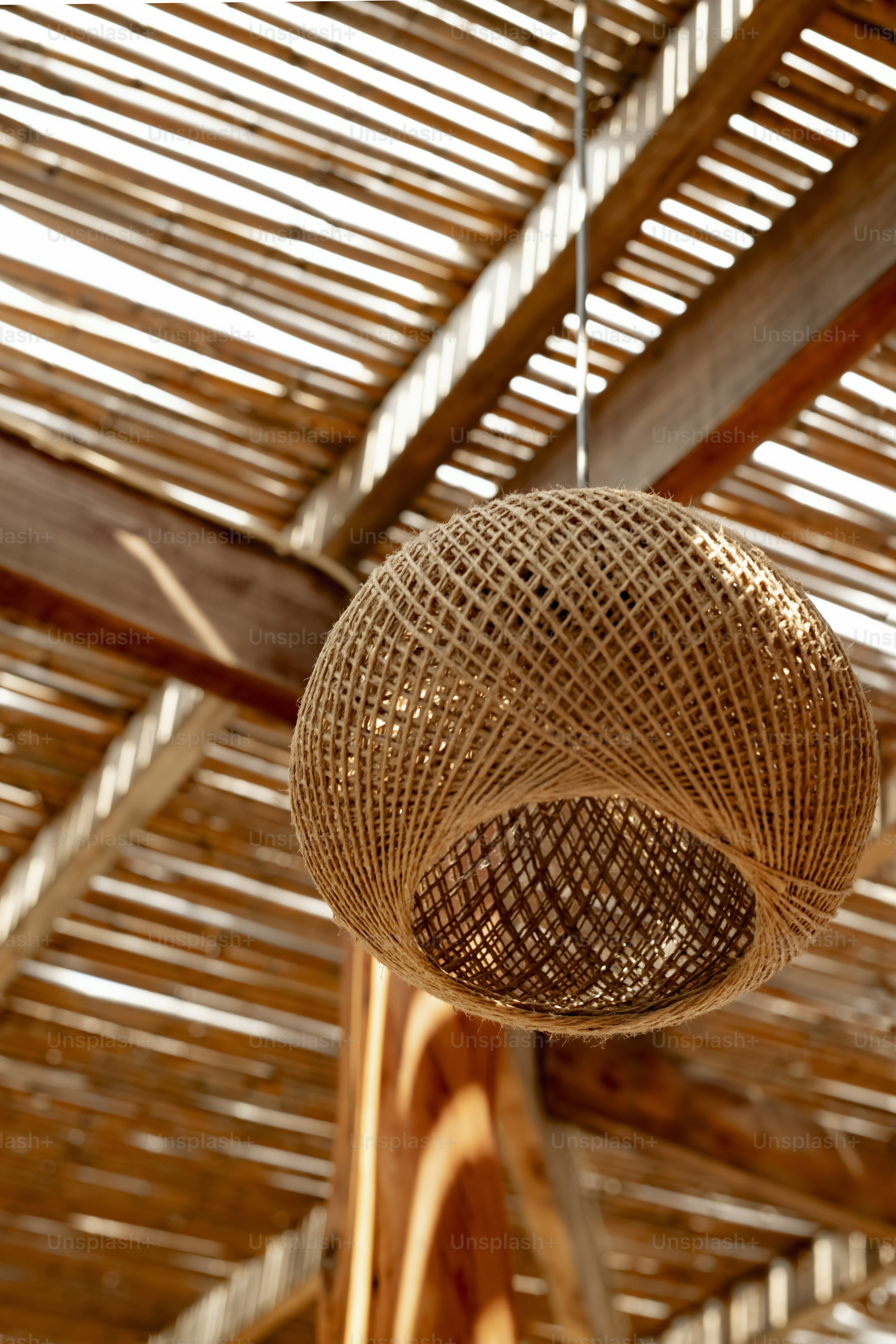 A wooden structure with a light fixture hanging from it photo – Summer ...