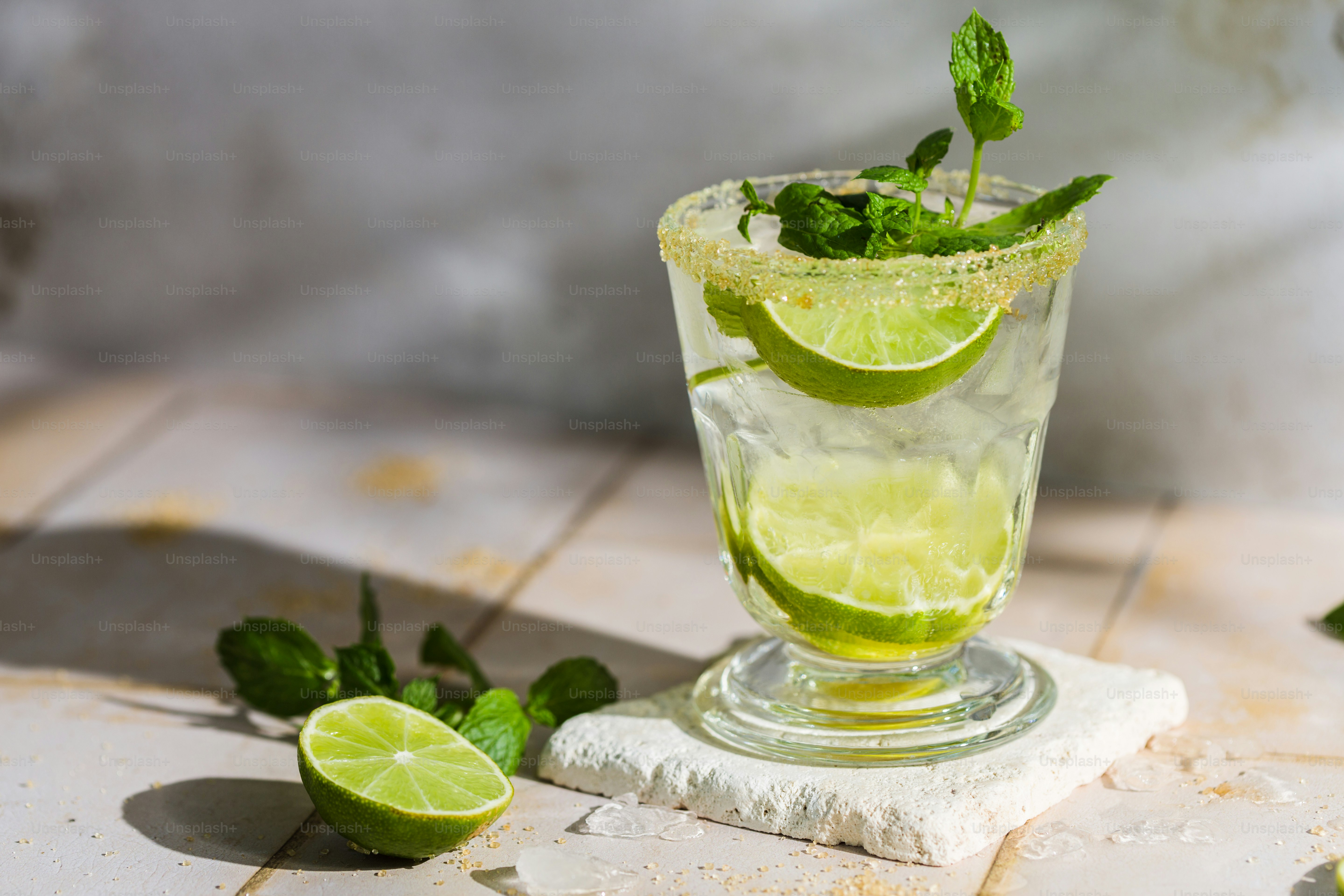 A glass filled with limeade sitting on top of a counter photo ...