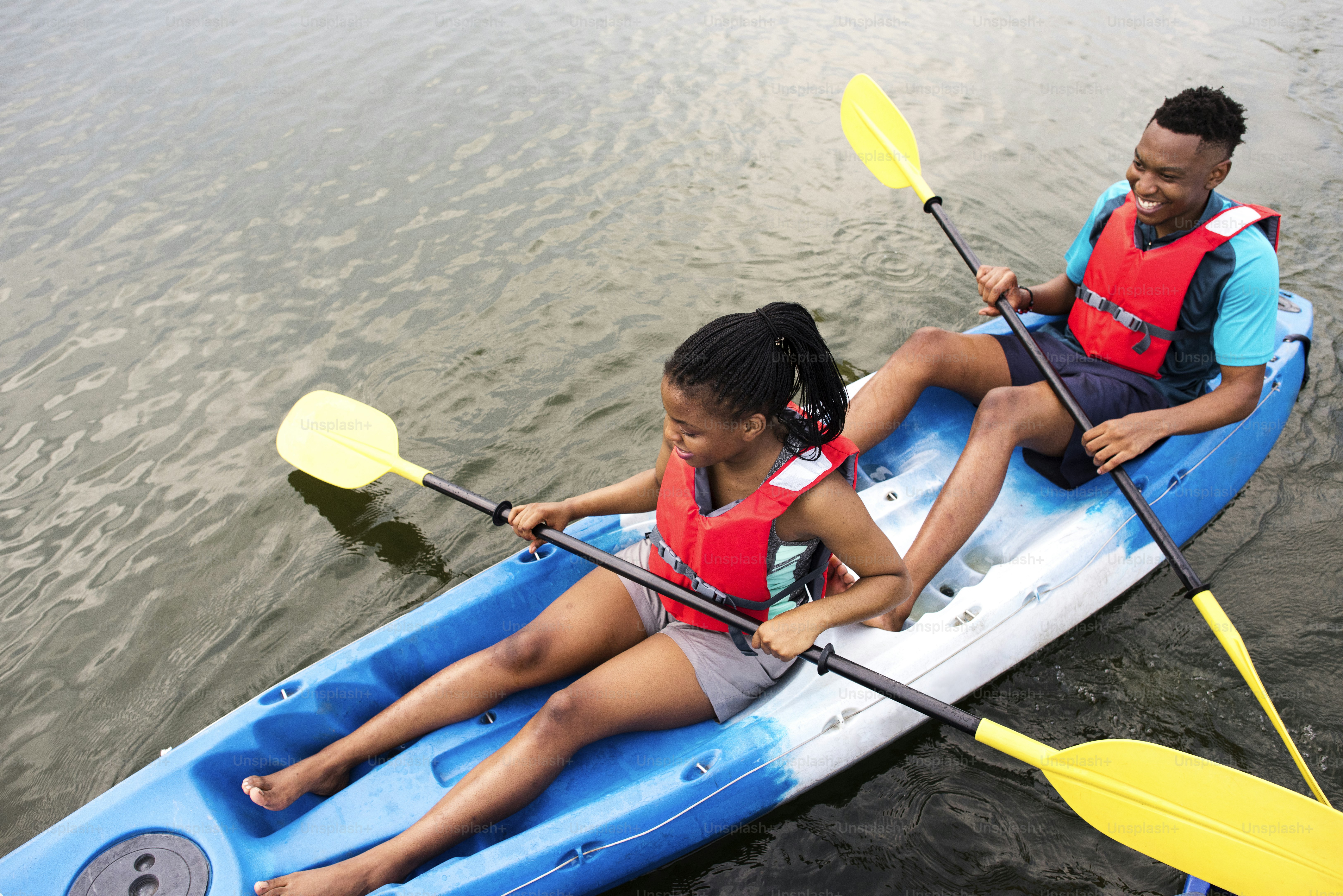 Couple canoeing in a lake photo – Outdoors Image on Unsplash