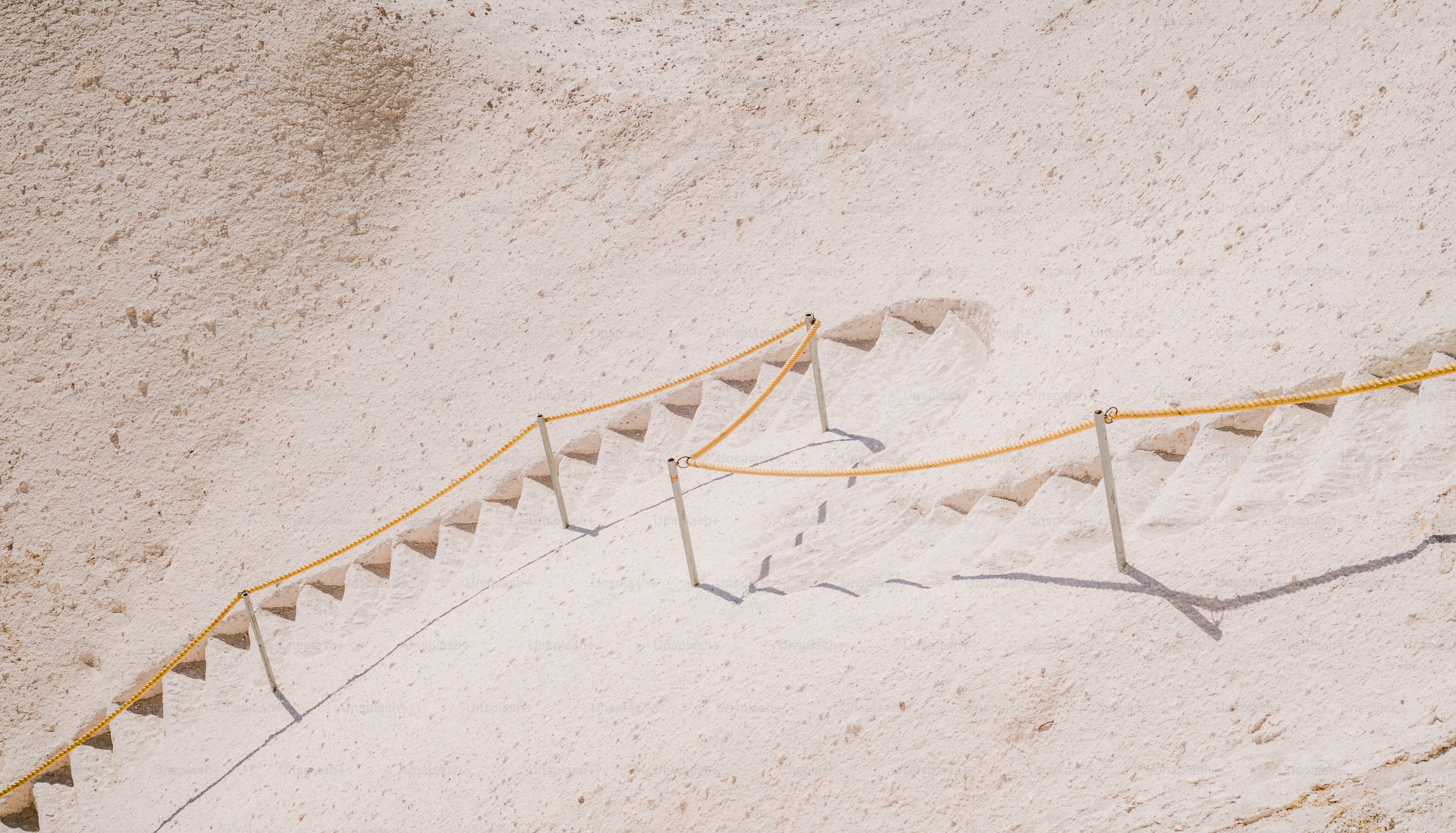 A staircase in the sand on a beach photo – Stairs Image on Unsplash