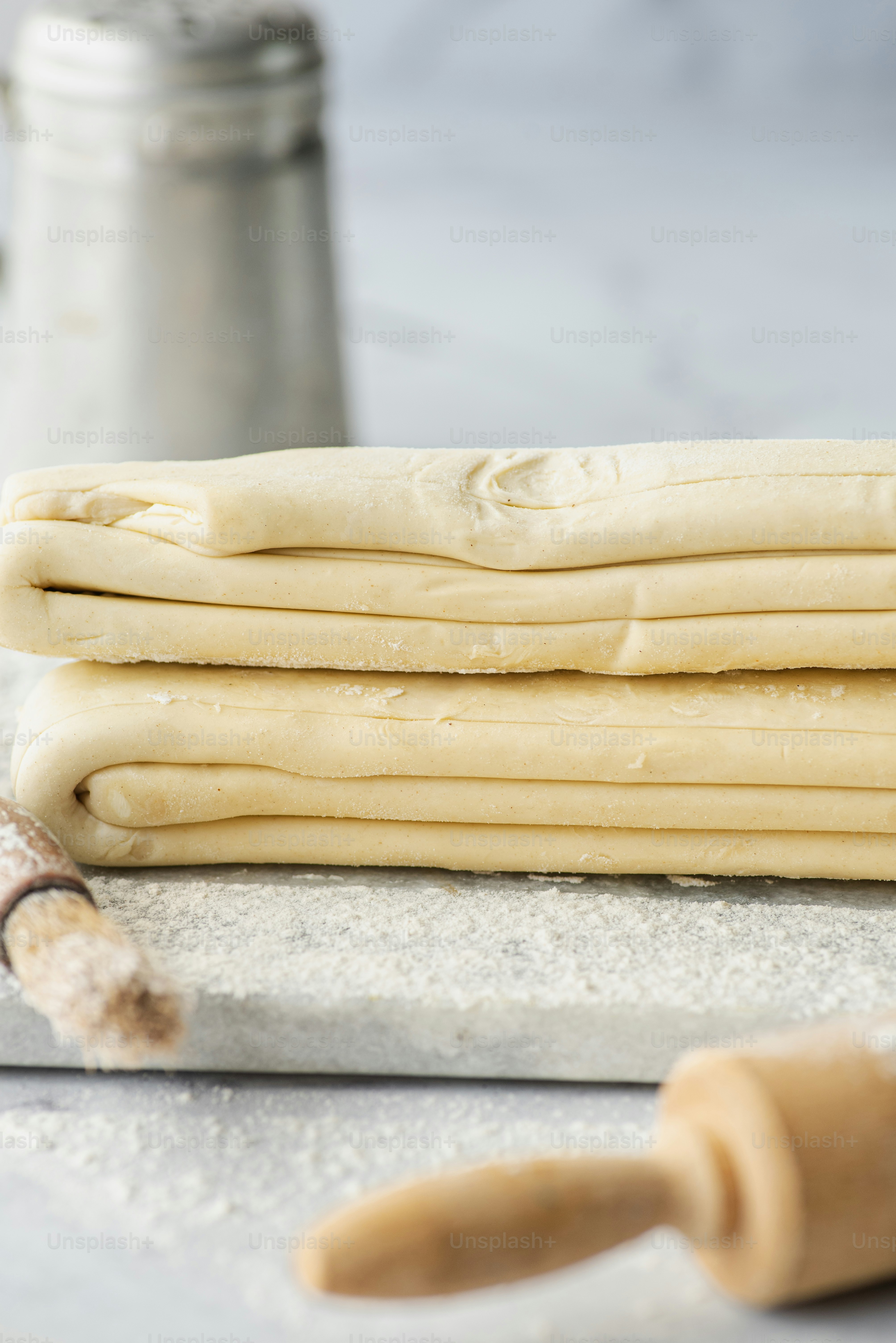 A stack of uncooked pizza dough on a counter photo – Sweet dough Image ...