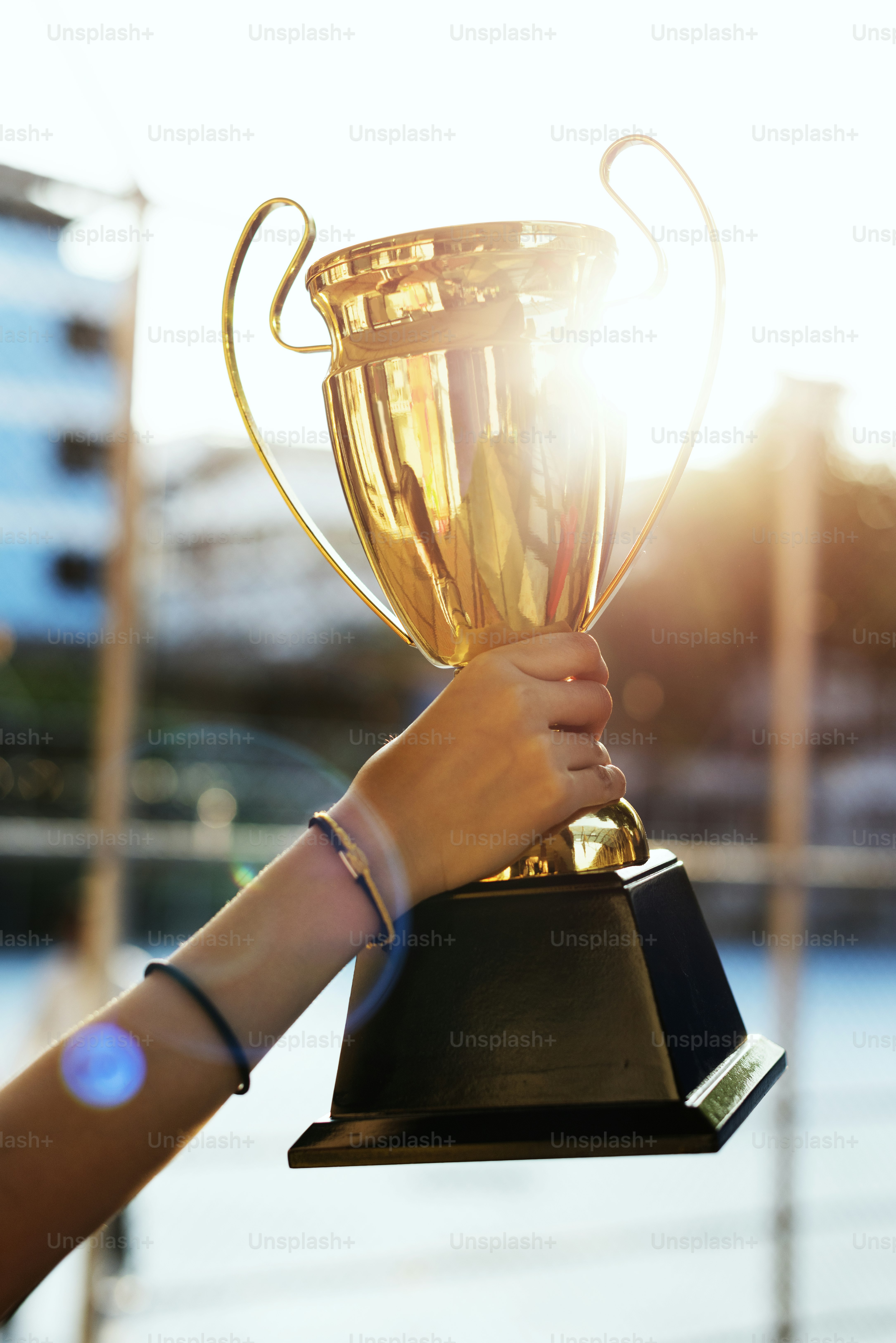 Feminine hand holding a trophy outdoors photo – Trophy Image on Unsplash