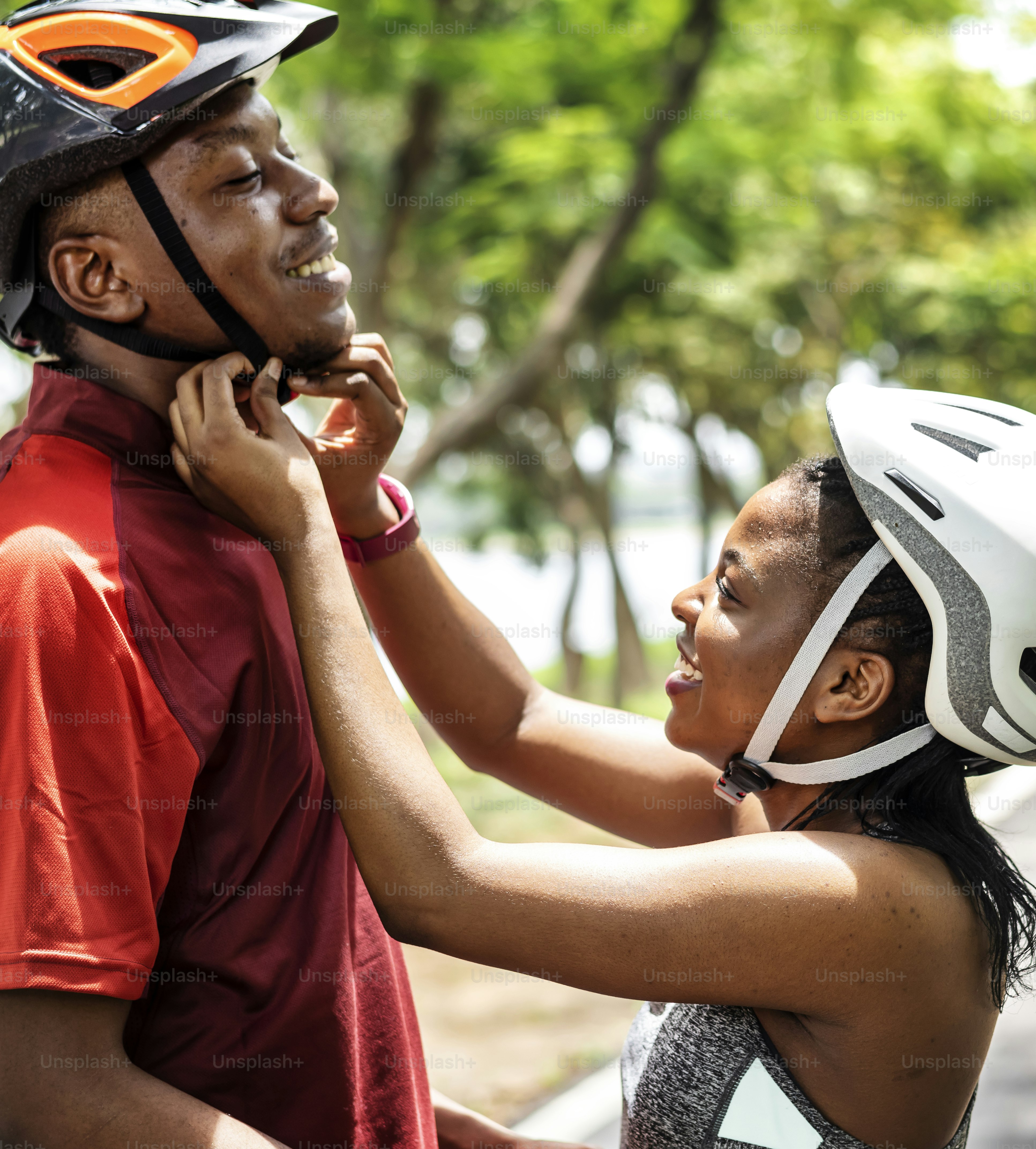 Woman fastens a bike helmet for her boyfriend photo – Sport Image on ...