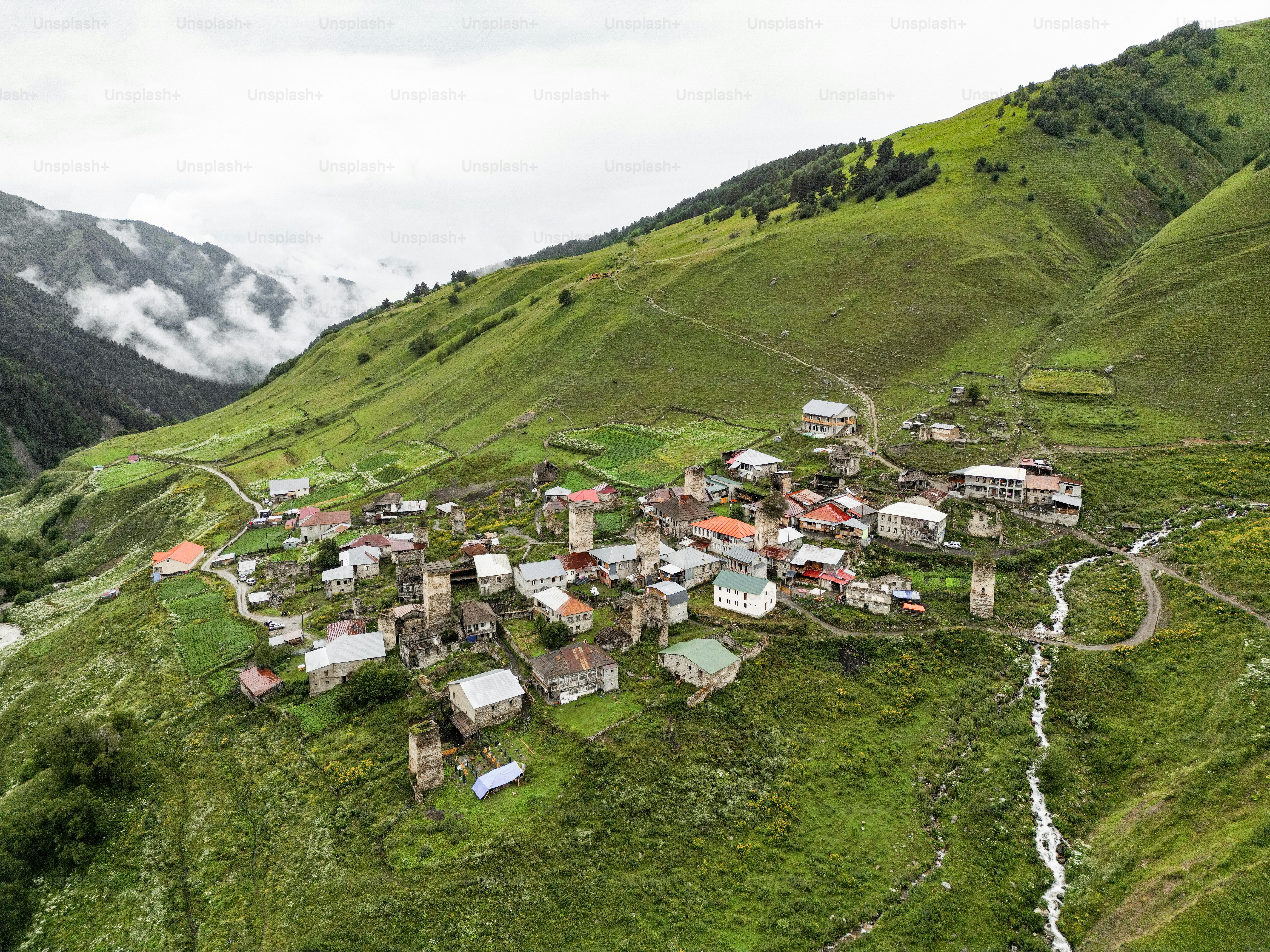 An aerial view of a small village in the mountains photo – Adishi Image ...
