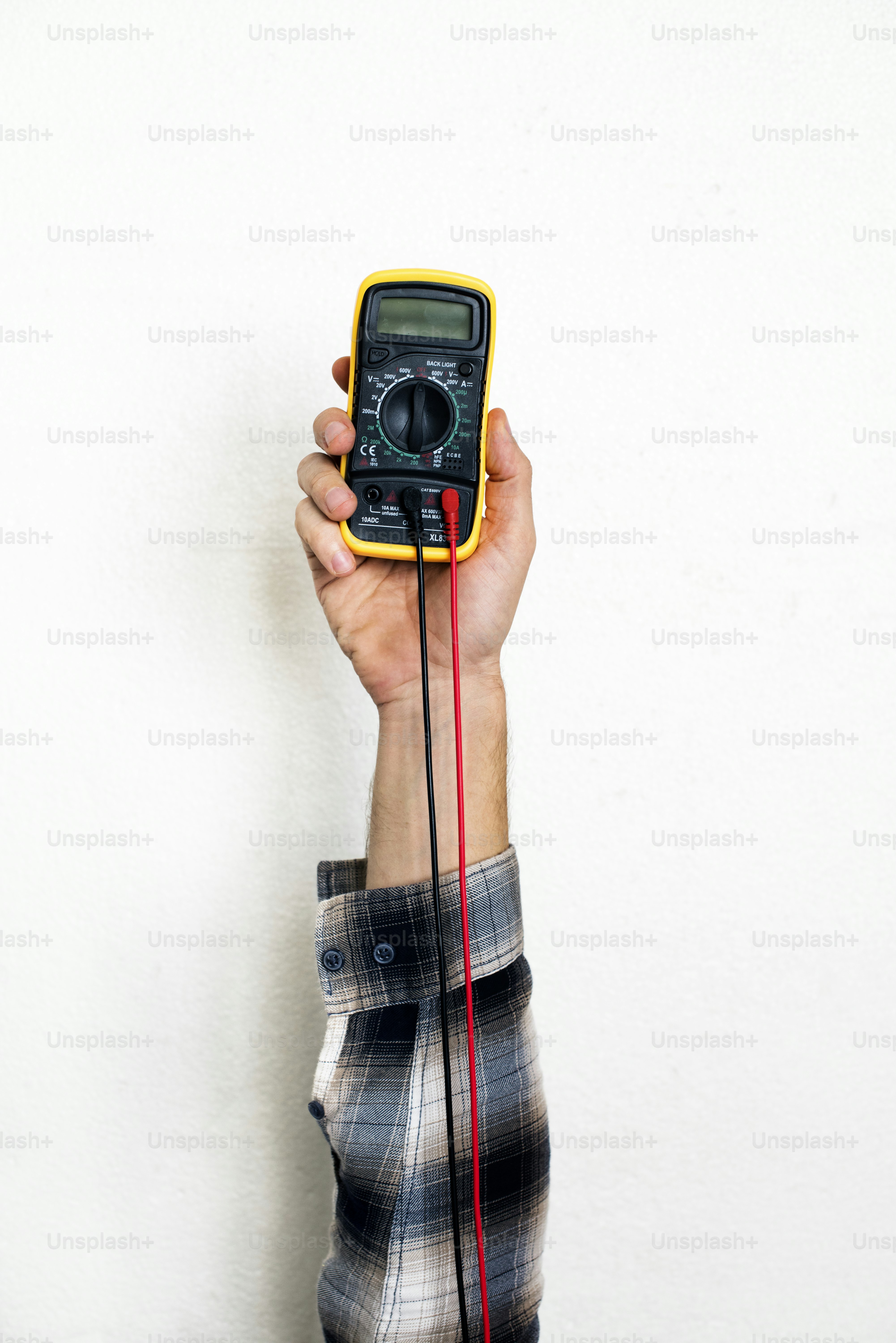 Hand holding electrics measure multimeter isolated on white photo ...