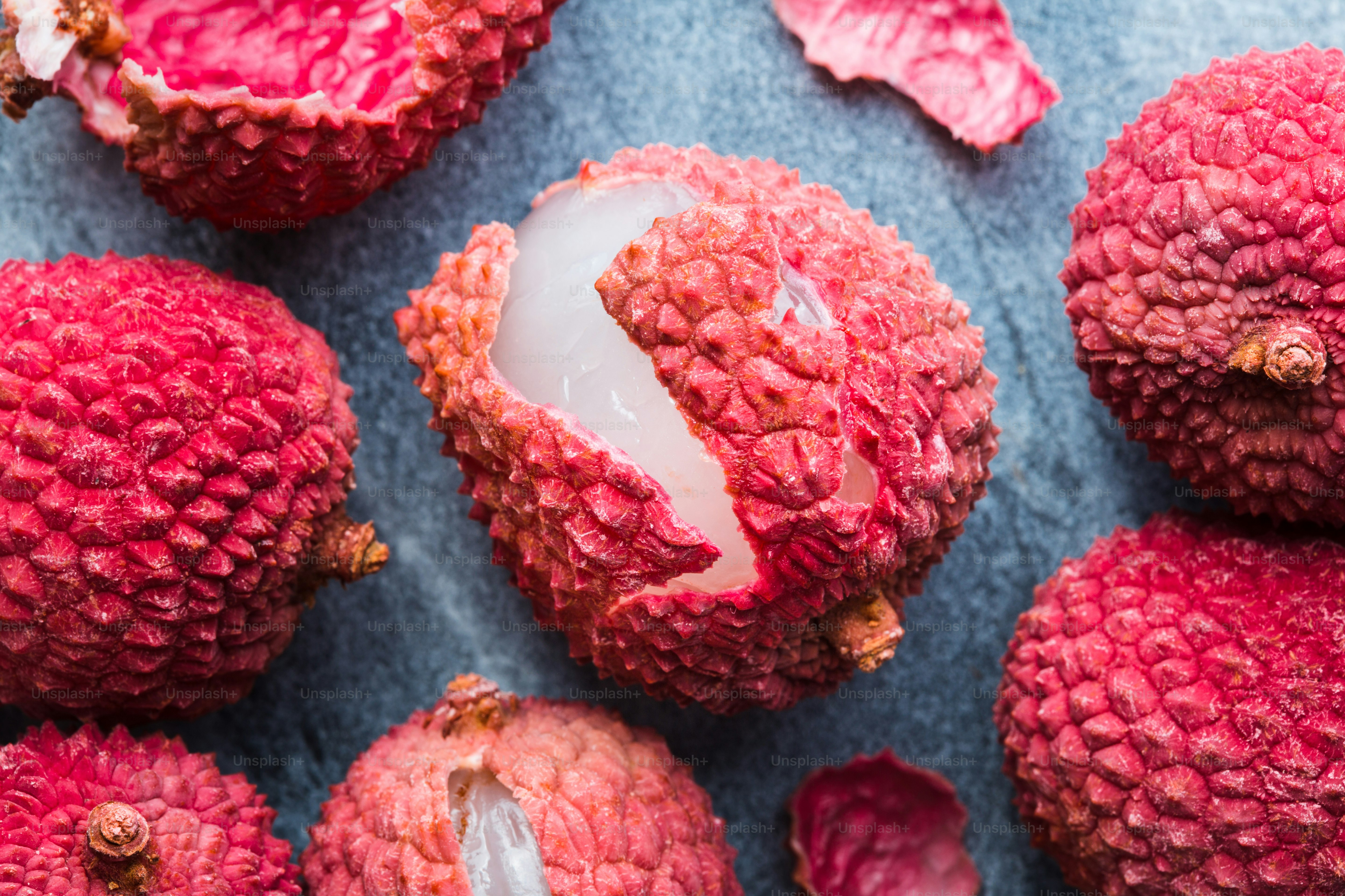 A bunch of red fruit sitting on top of a table photo – Fruit Image on ...