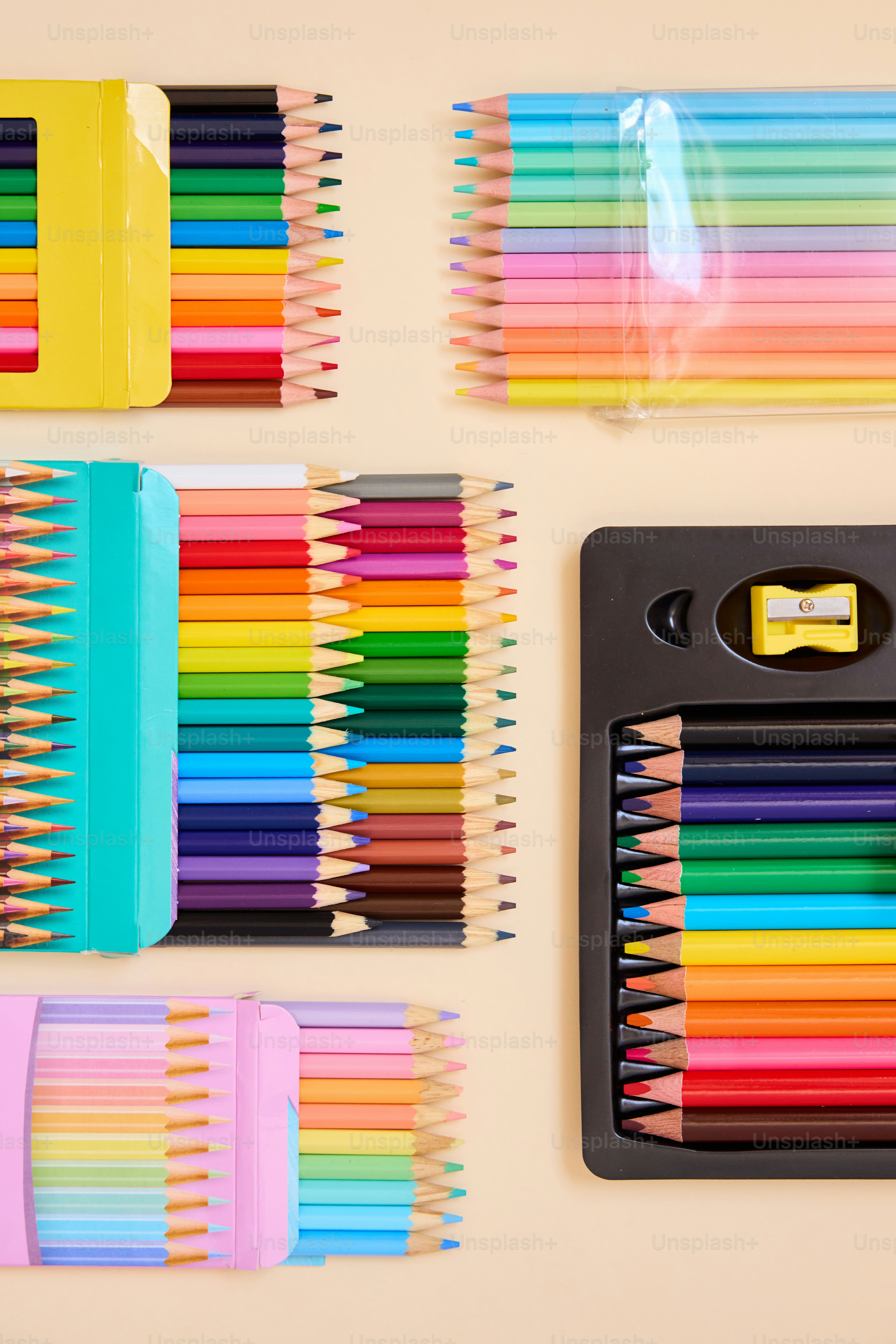 A group of colored pencils sitting on top of a table photo – School ...