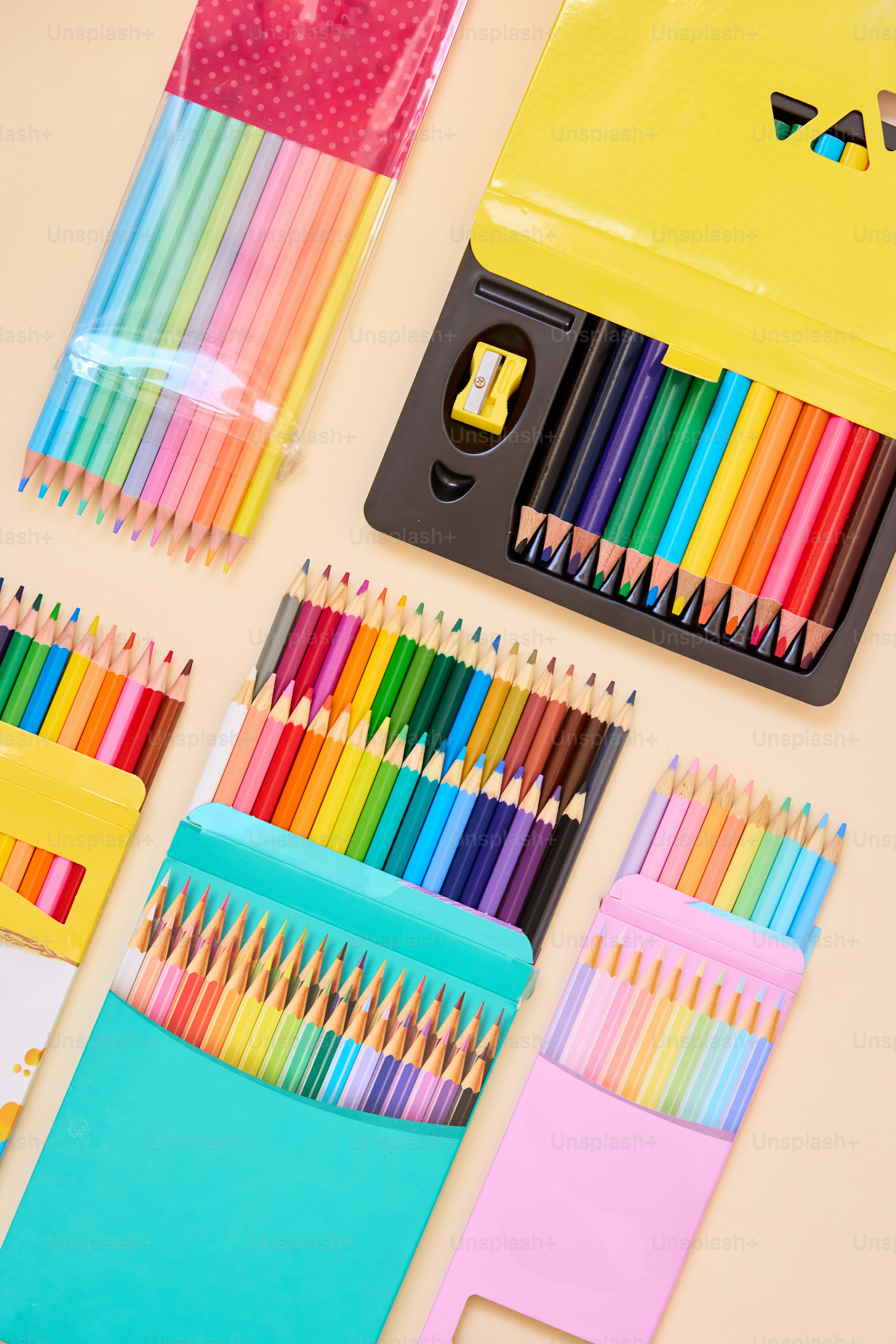 A bunch of pencils and a case of pencils on a table photo – Colored ...