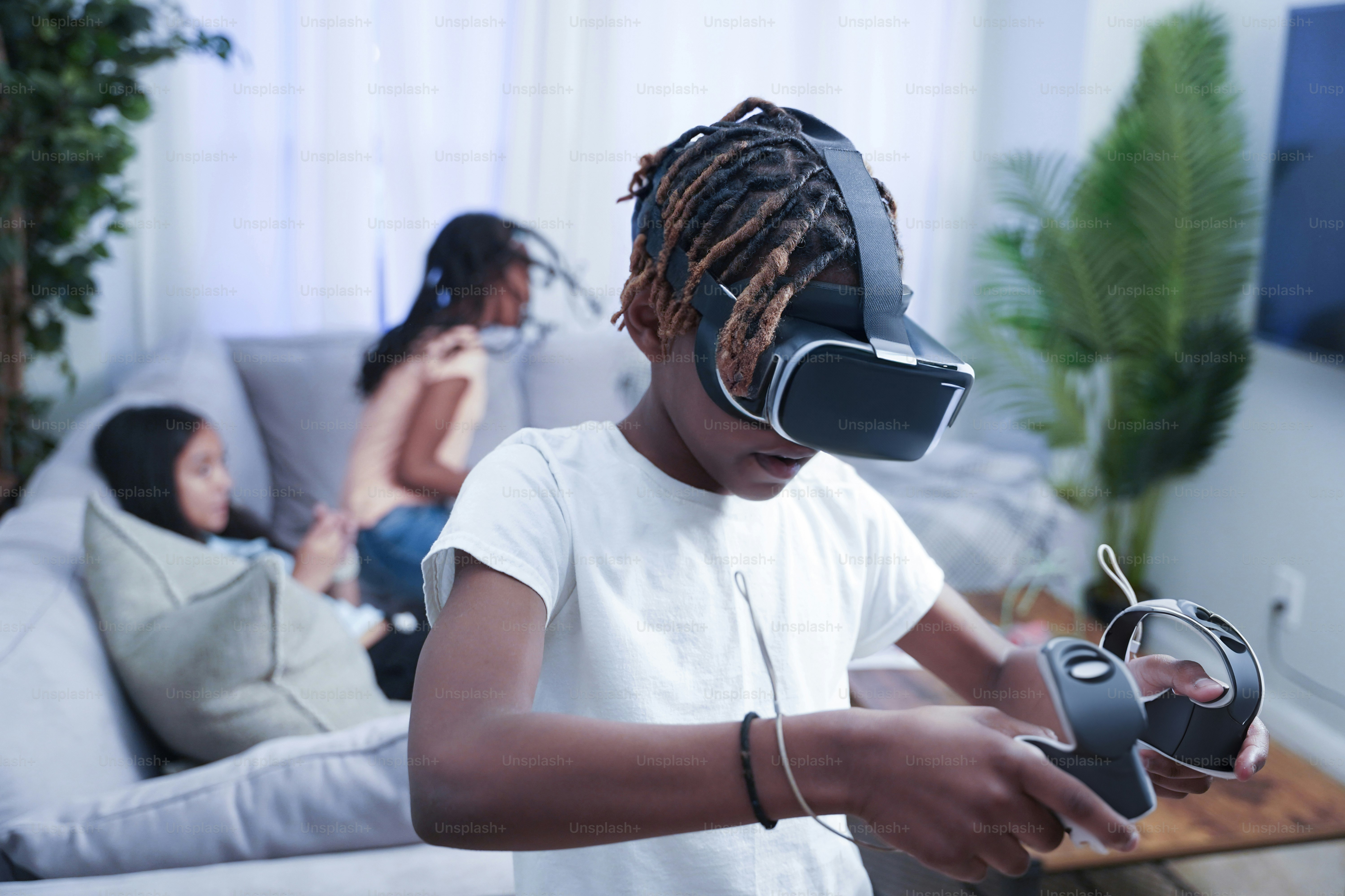 A young person wearing a virtual reality headset photo – Tweens Image ...