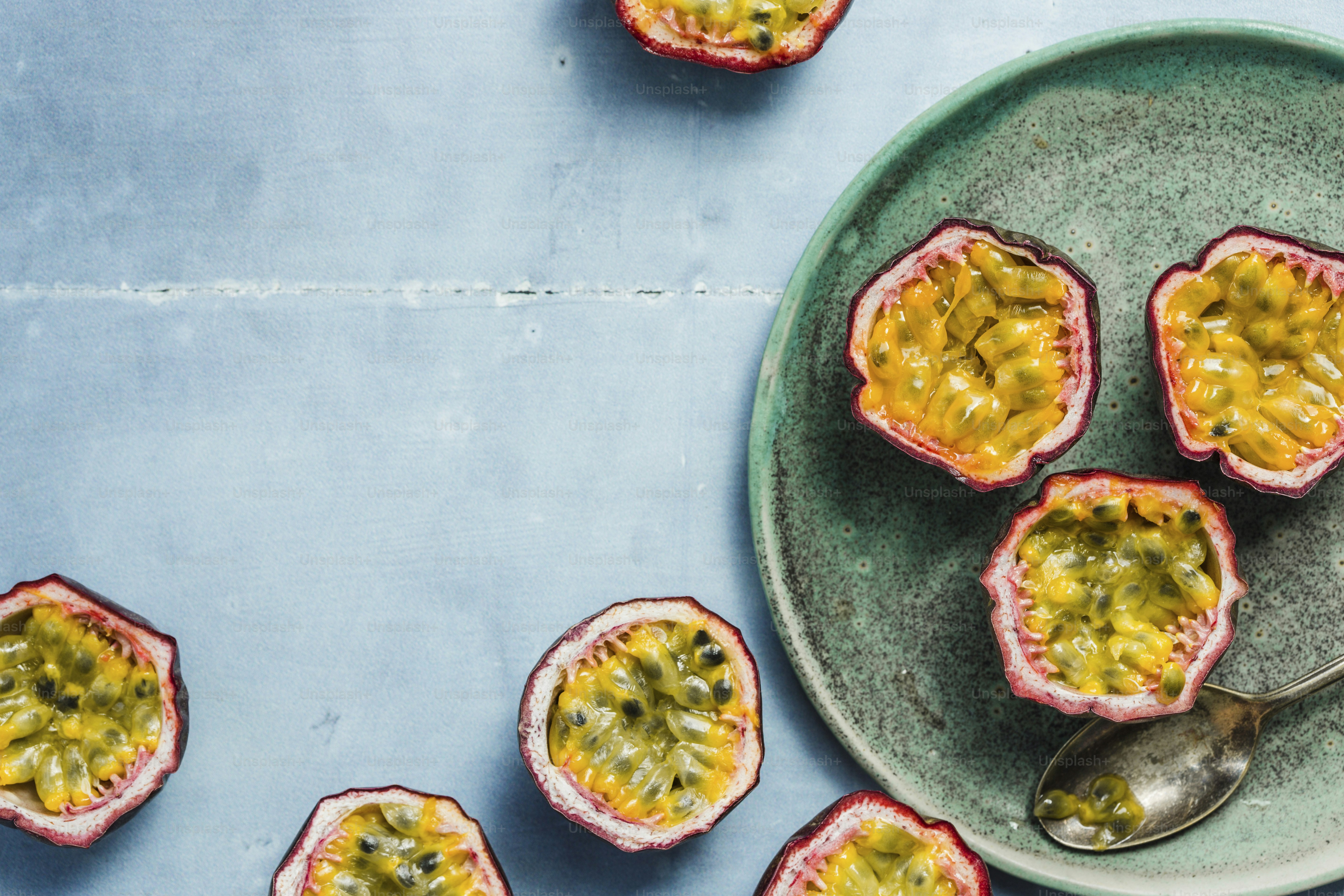 A plate topped with cut open fruit on top of a table photo – Texture ...