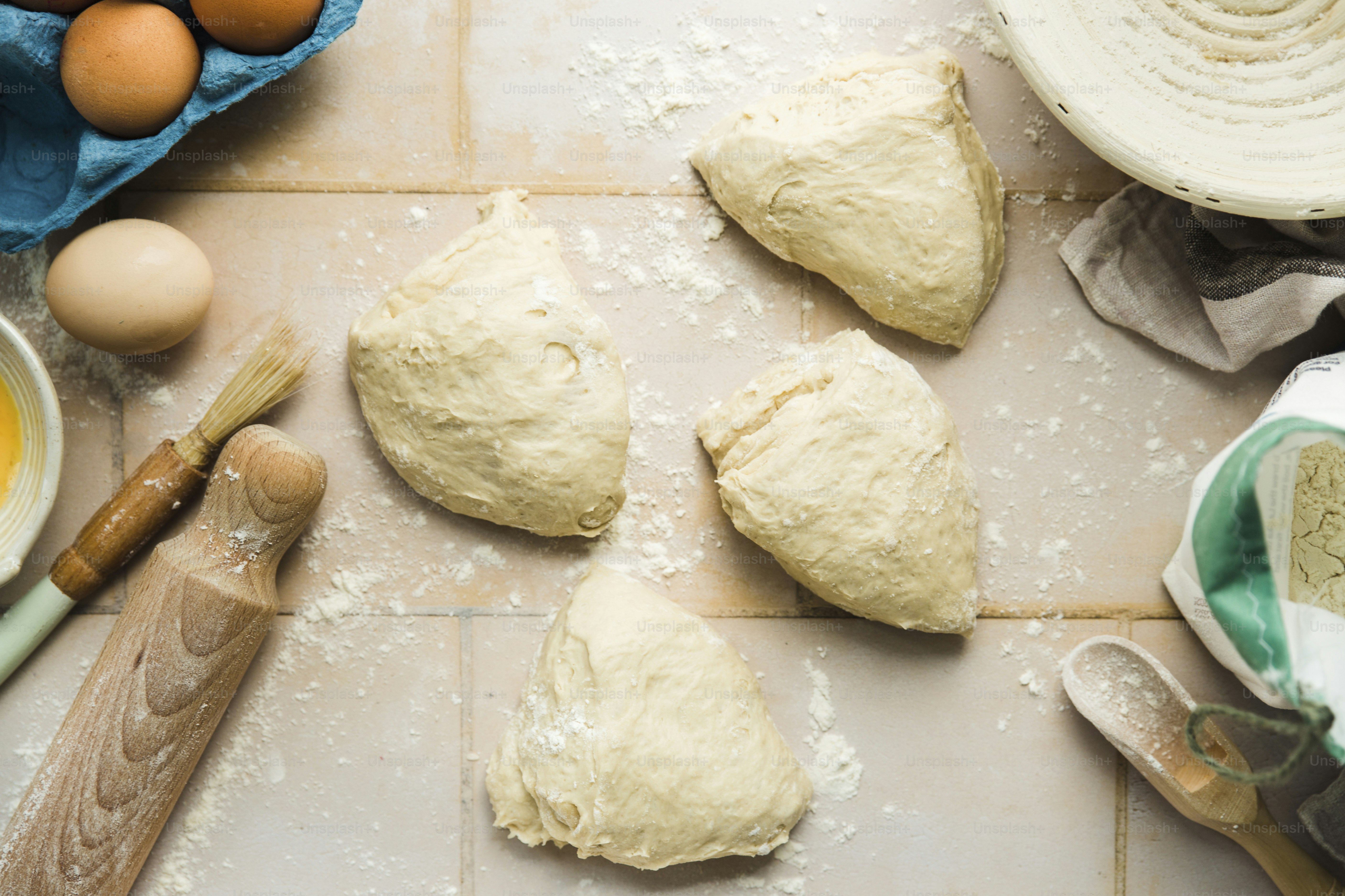 A table topped with lots of dough and eggs photo – Cooking with dough ...