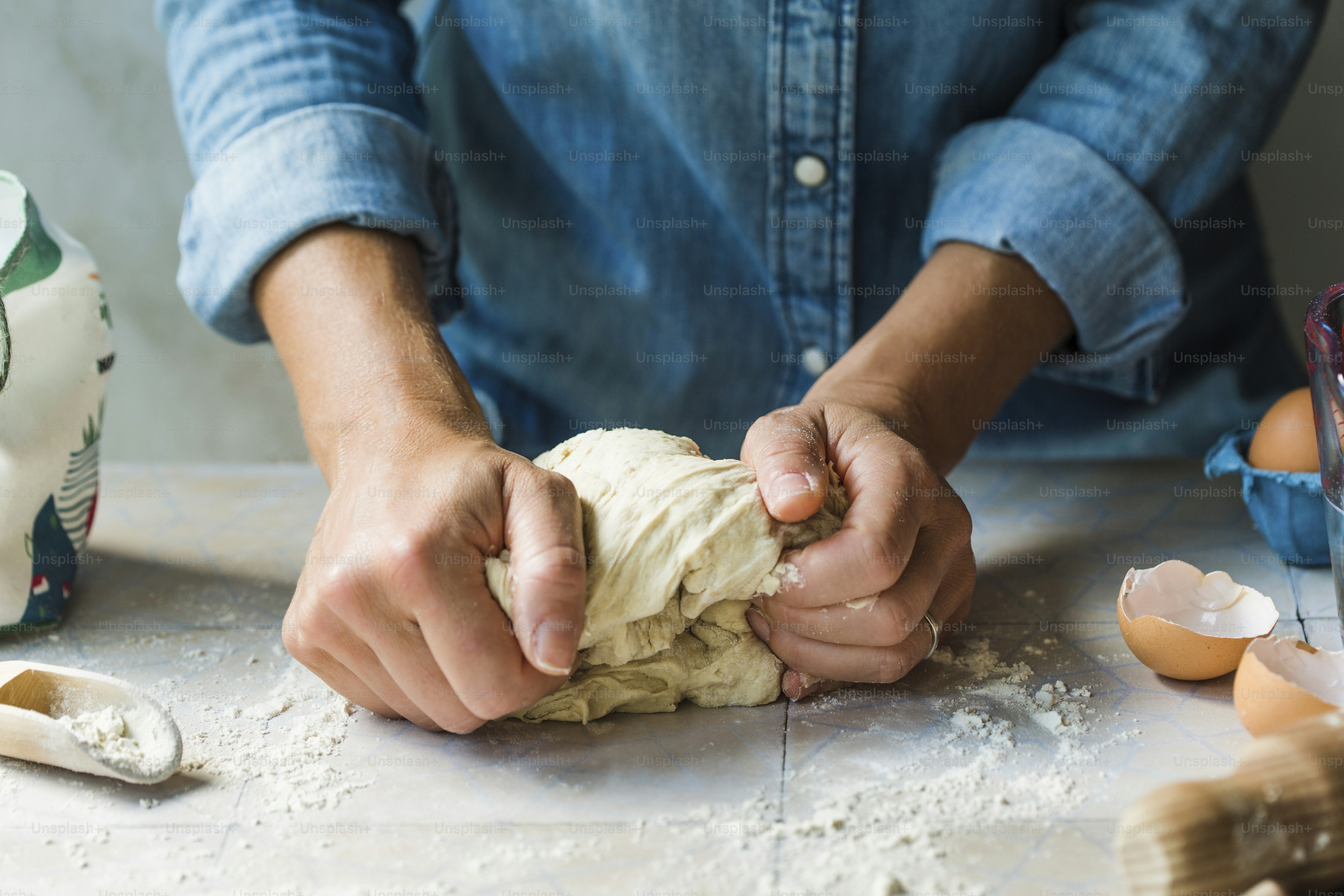 A person kneading dough on top of a table photo – Cooking Image on Unsplash